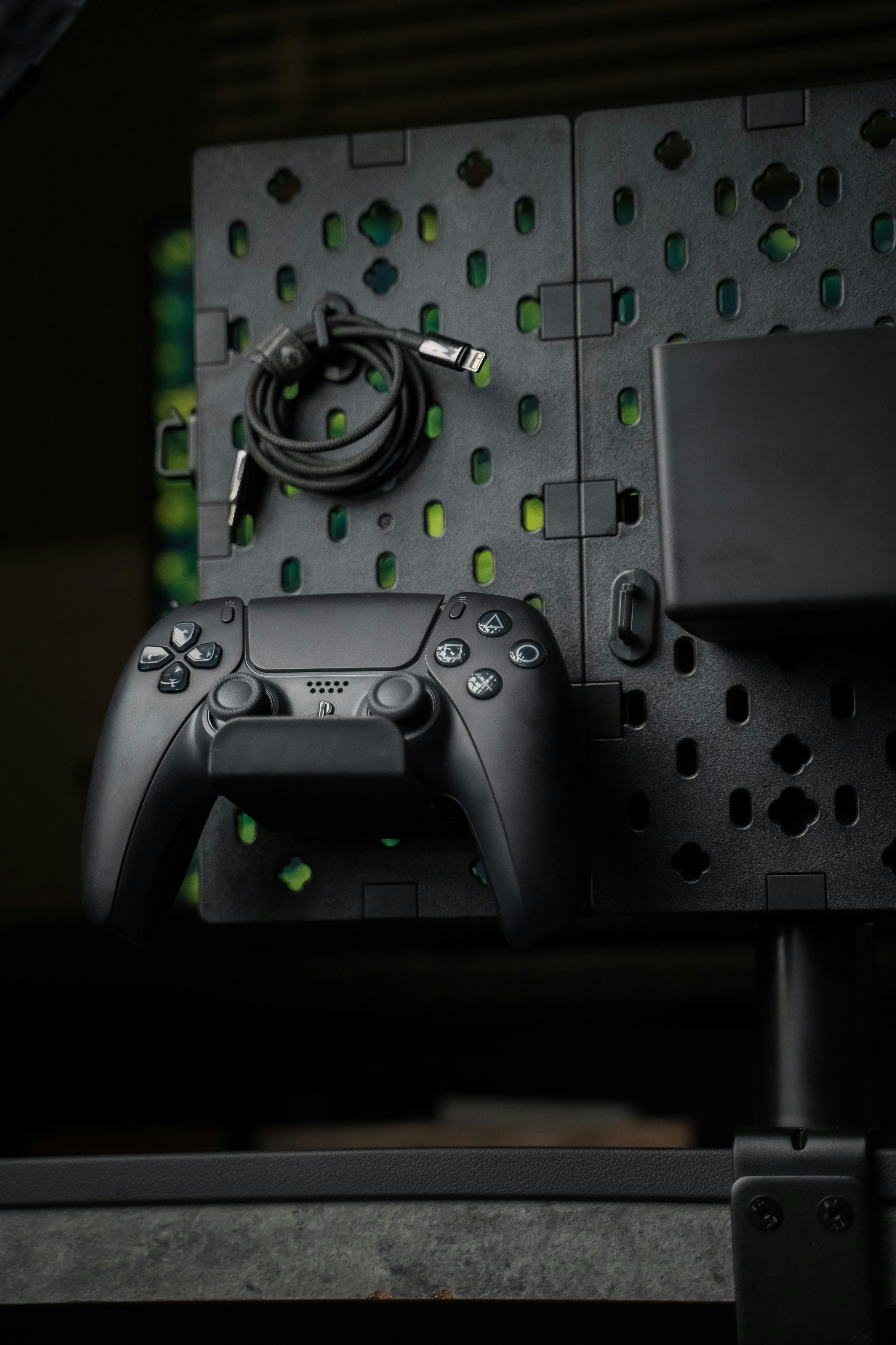 PlayStation Controller and Wire on Gray Wall · Free Stock Photo