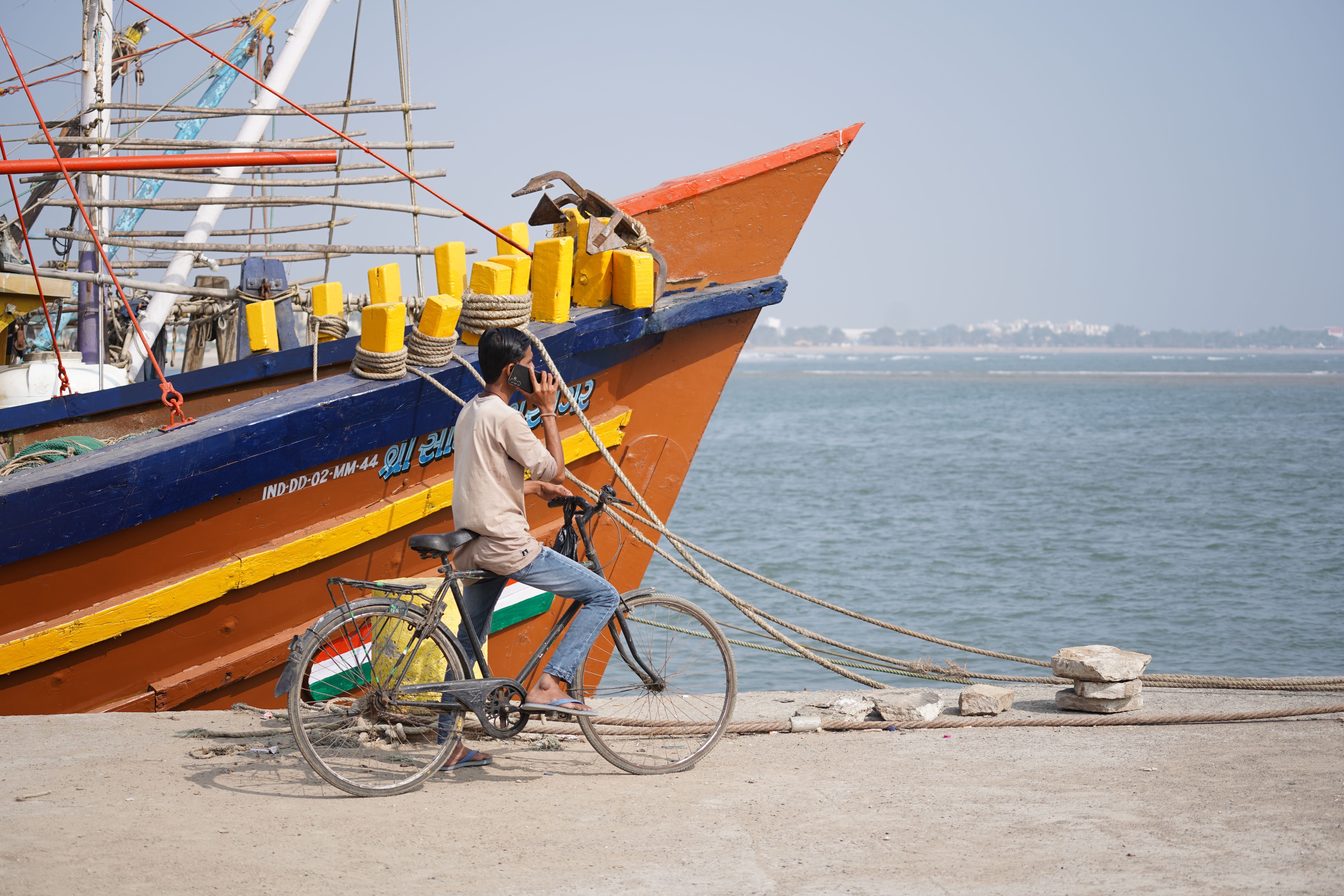 Man Riding Bike Beside Ship · Free Stock Photo