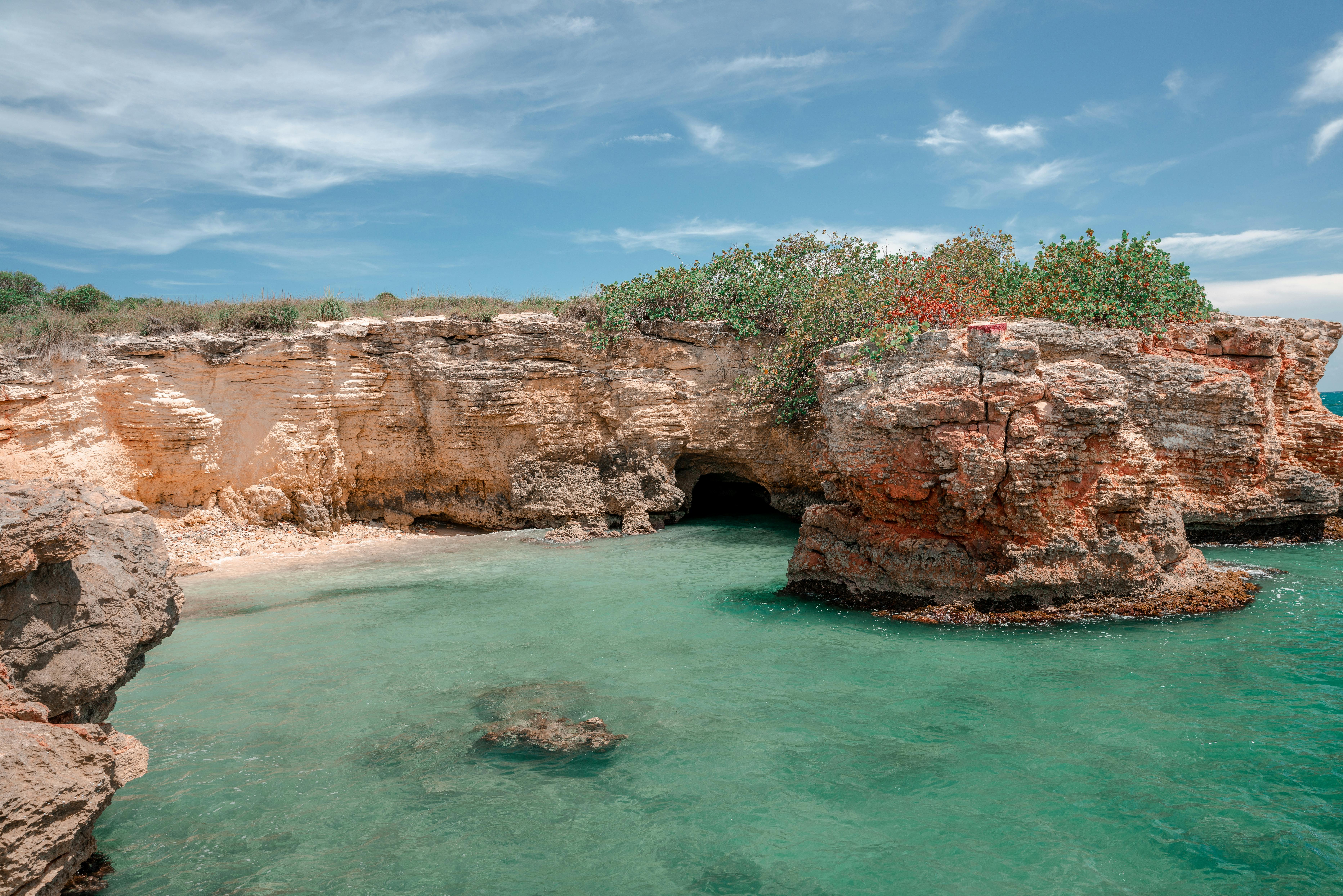 Rocks and Cave on Sea Shore in Red Cape in Puerto Rico · Free Stock Photo