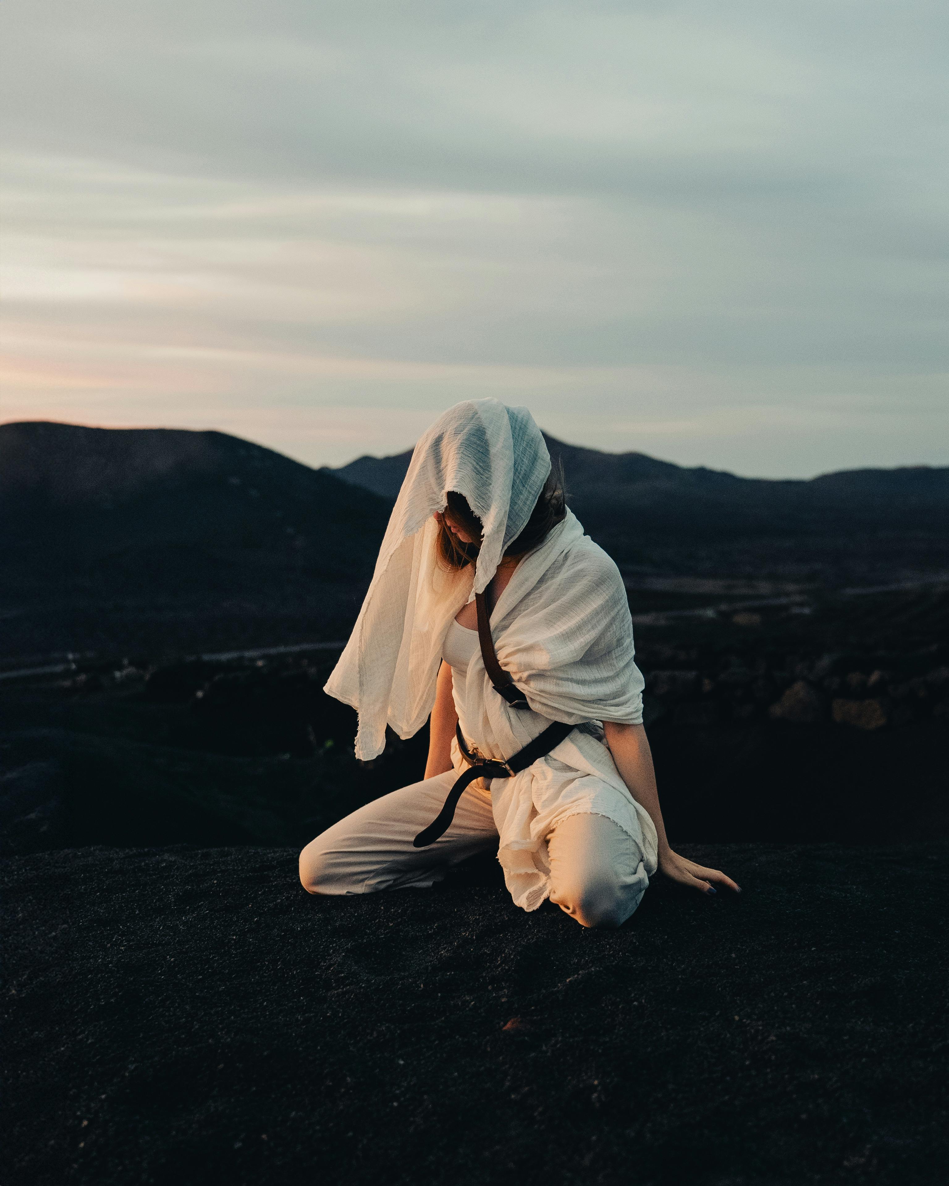 Woman in White Clothes and Veil Kneeling on Ground · Free Stock Photo