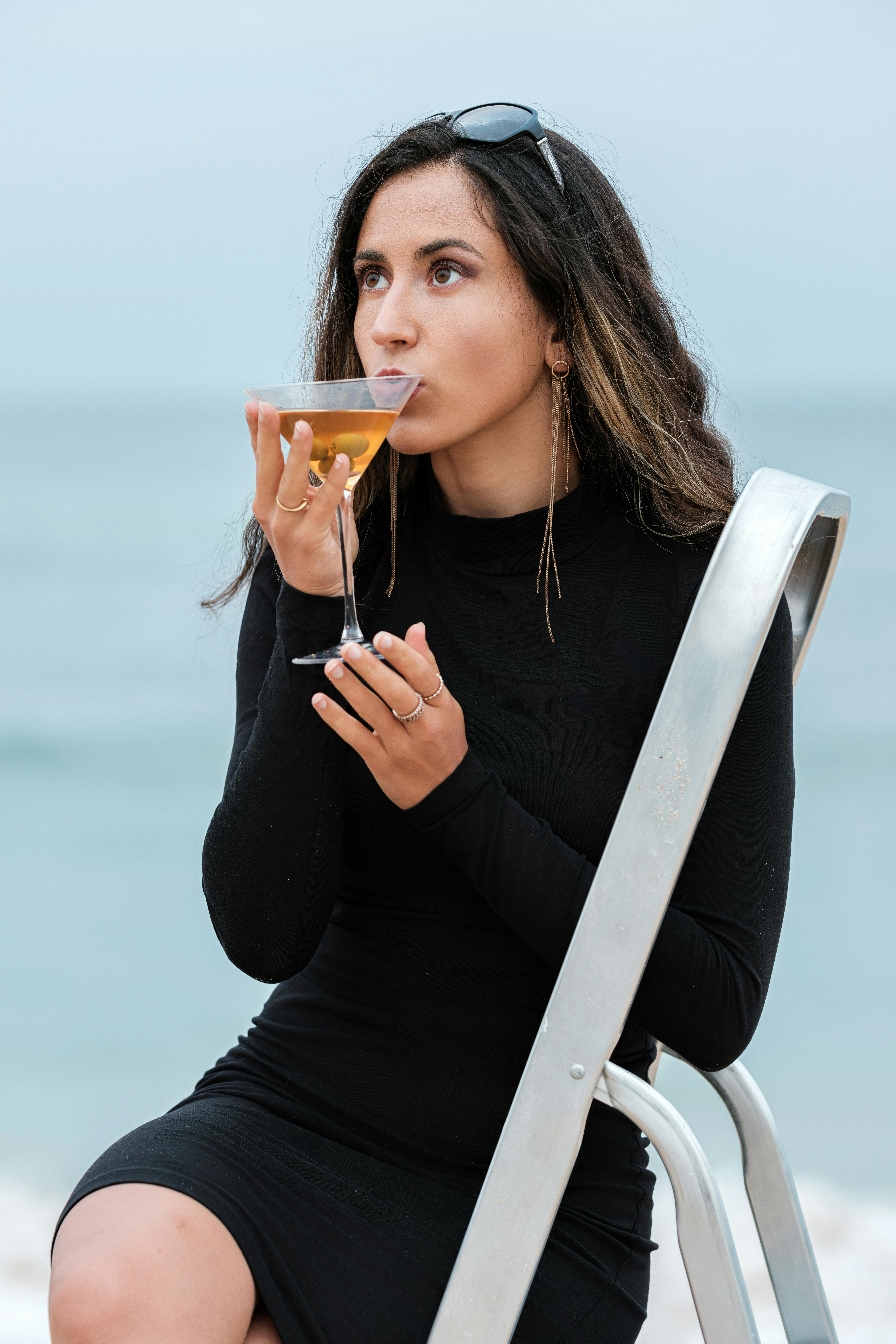 Portrait of Woman Drinking Cocktail on Ladder · Free Stock Photo