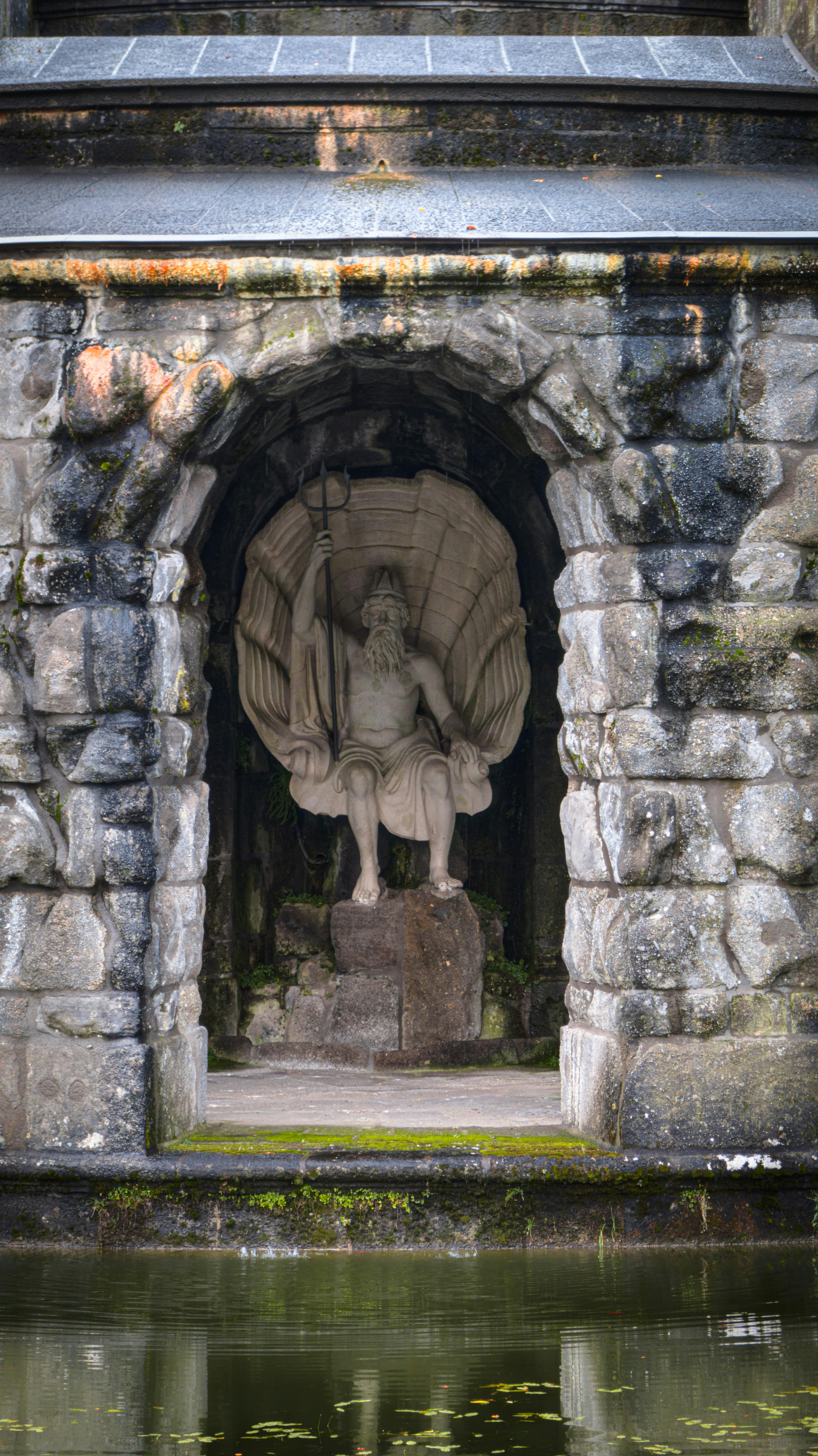 Neptune Statue in Wall over Pond · Free Stock Photo