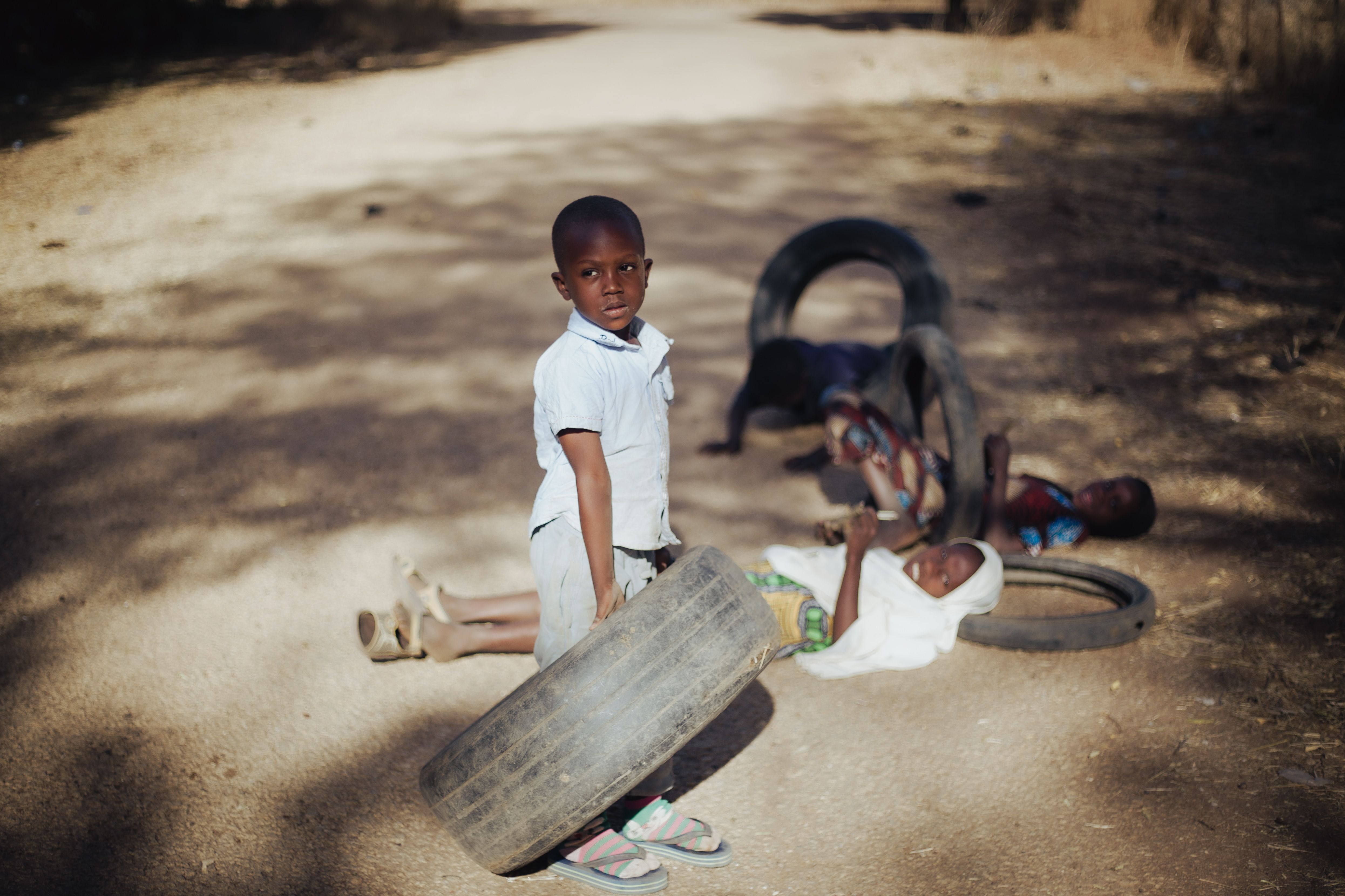 African Boys Running With Tires Photos, Download The BEST Free African ...