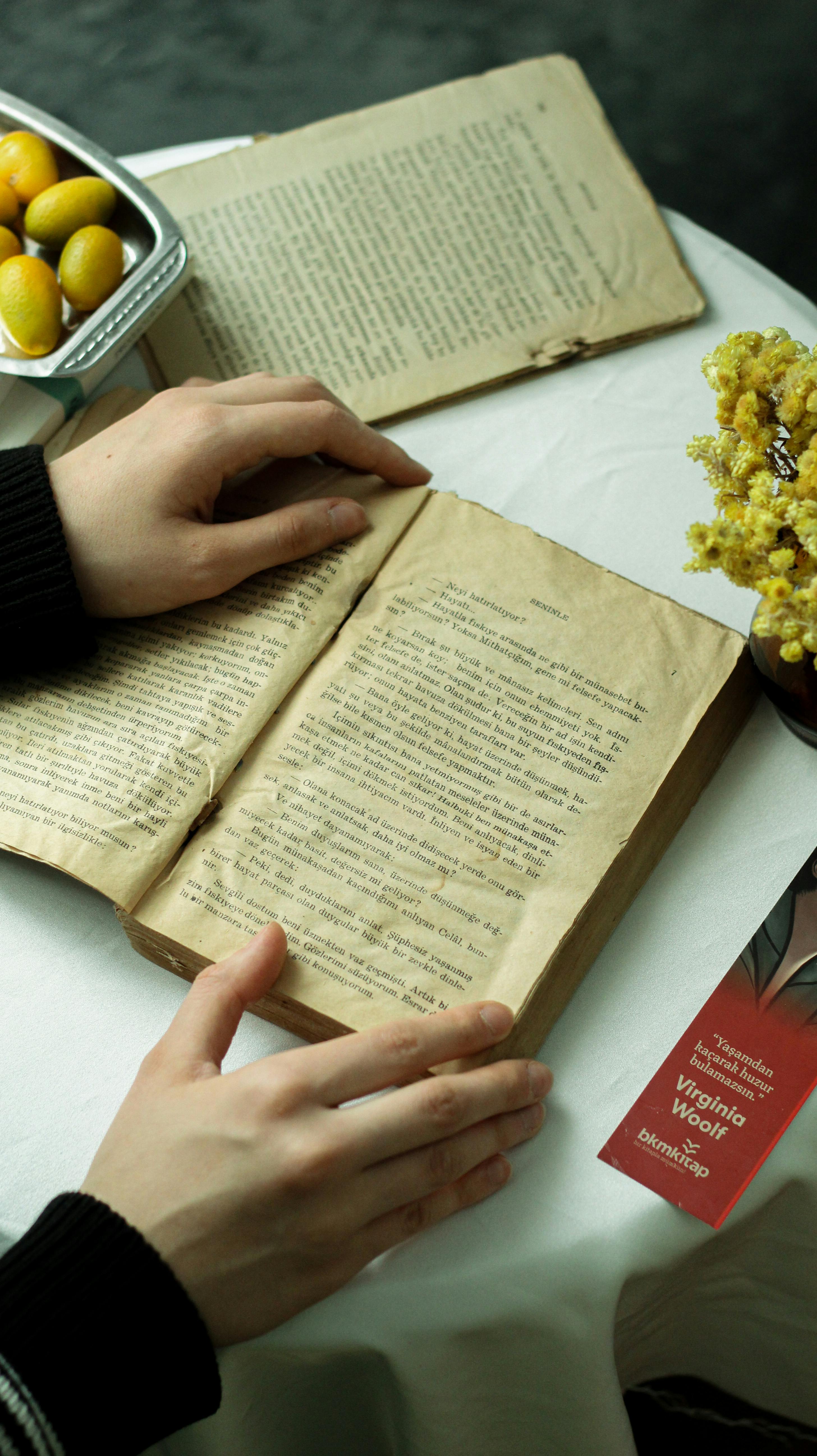 Woman Hands on Book Pages · Free Stock Photo