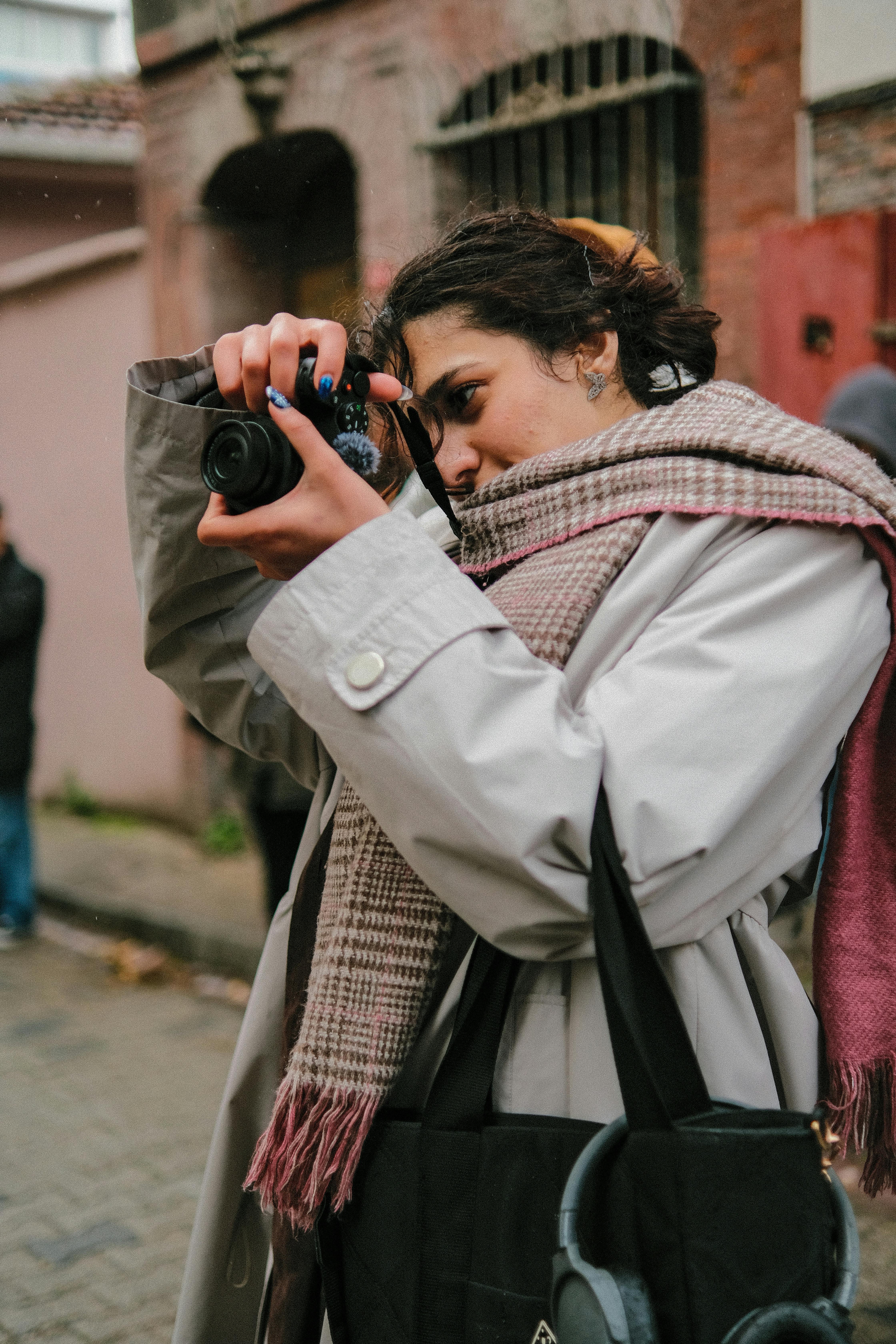 A woman taking a picture with her camera · Free Stock Photo