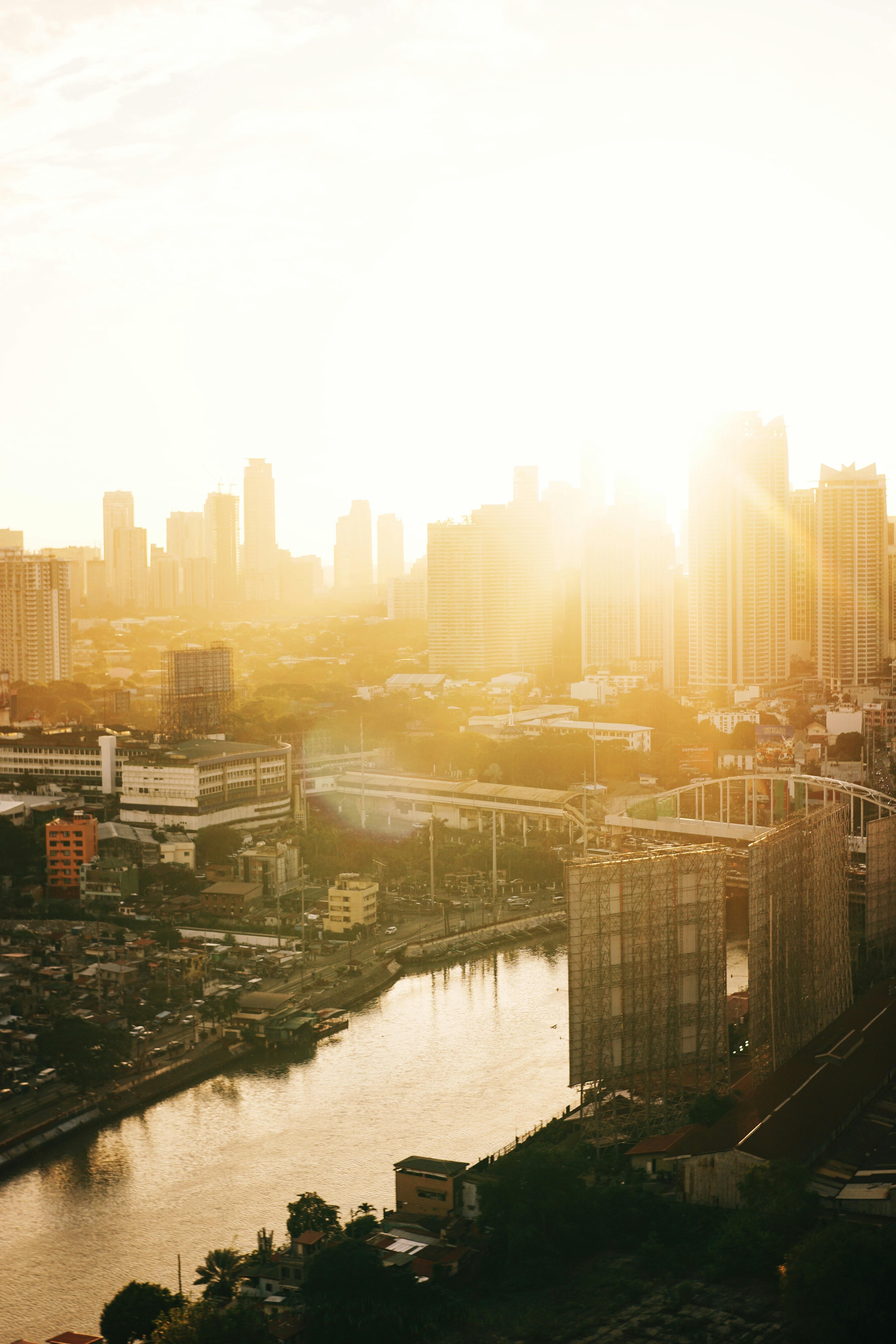 Sunset Sunlight over City with River · Free Stock Photo