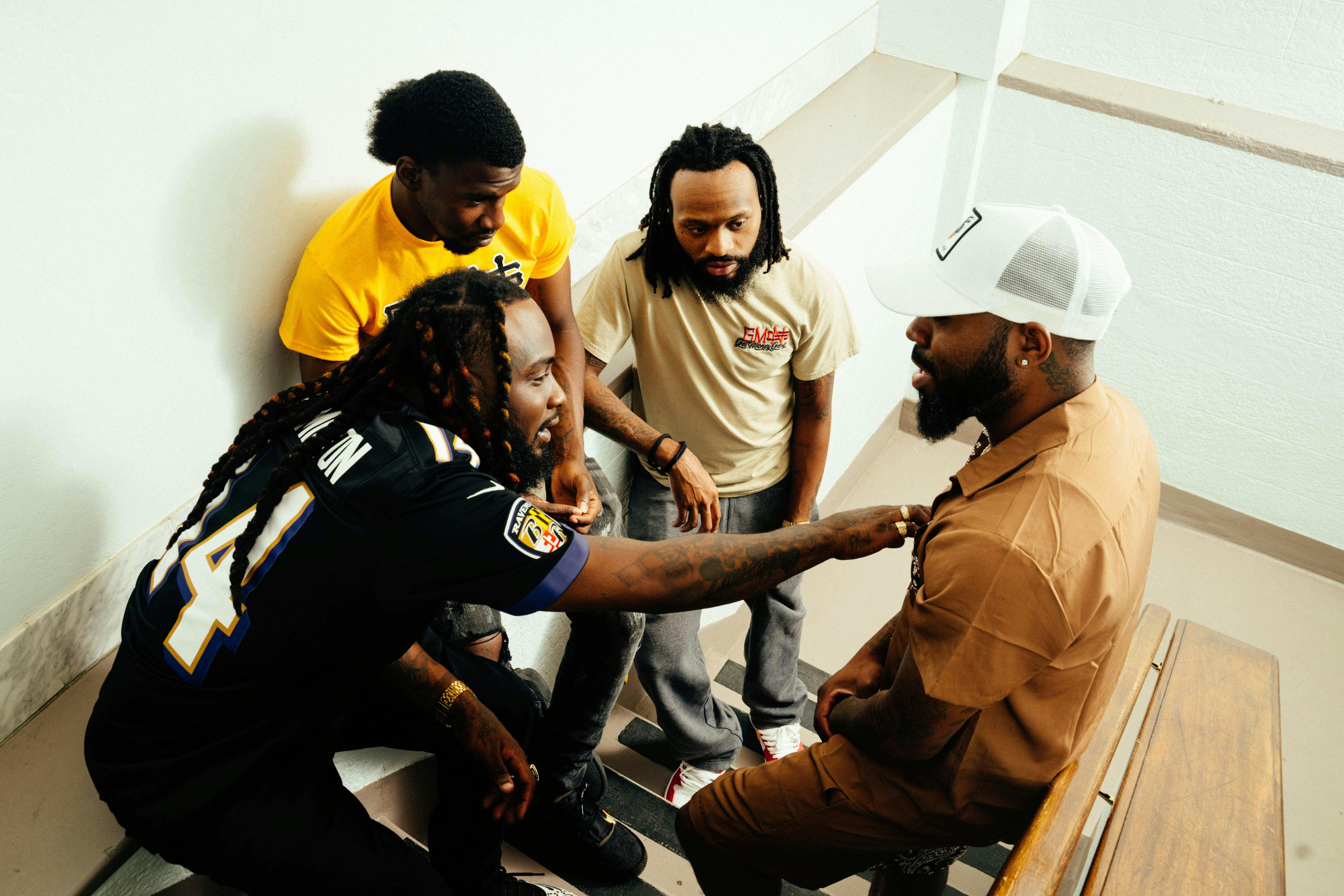 Group of Friends Discussing on the Staircase · Free Stock Photo