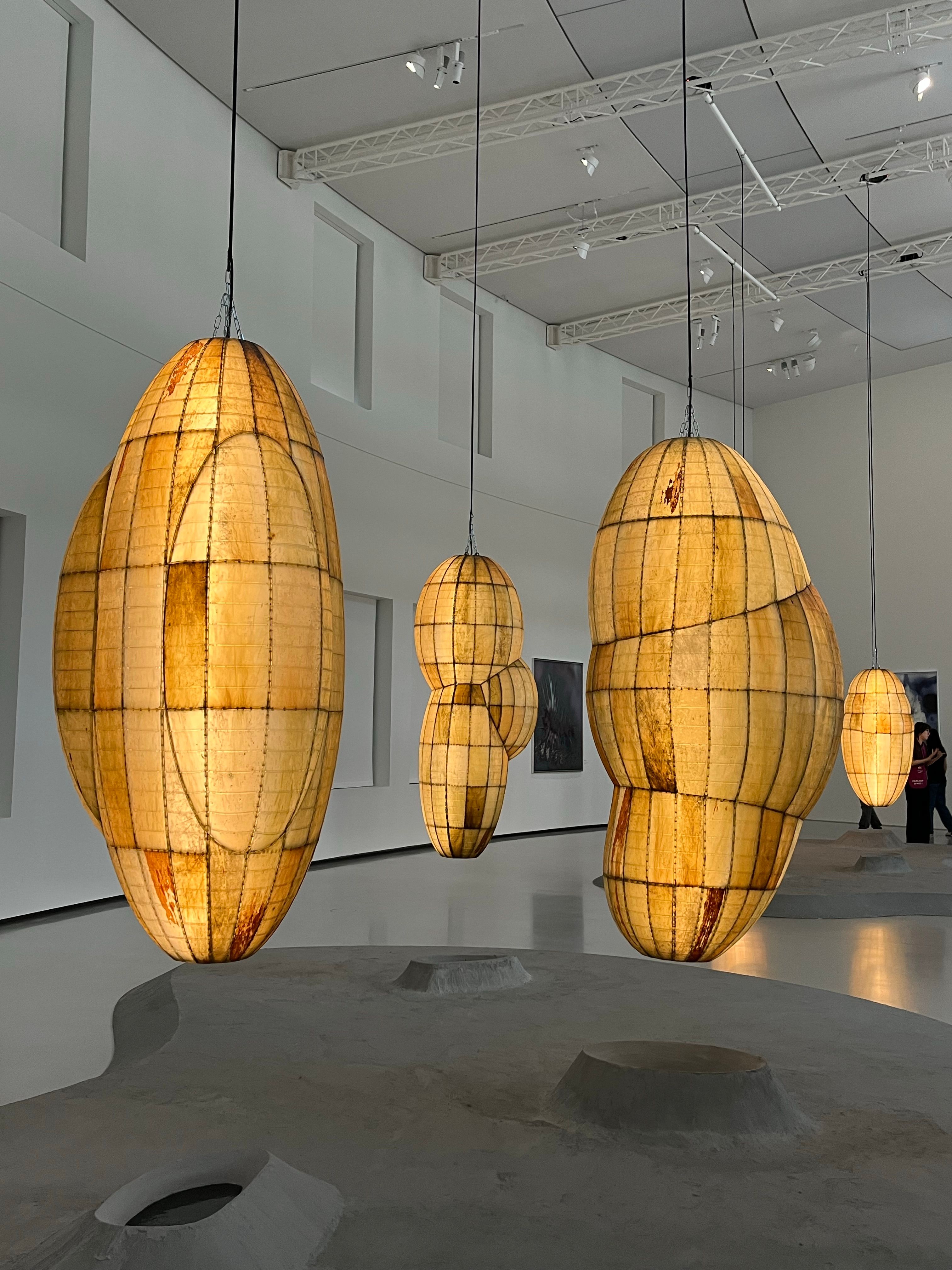 A group of three hanging lamps in a museum · Free Stock Photo