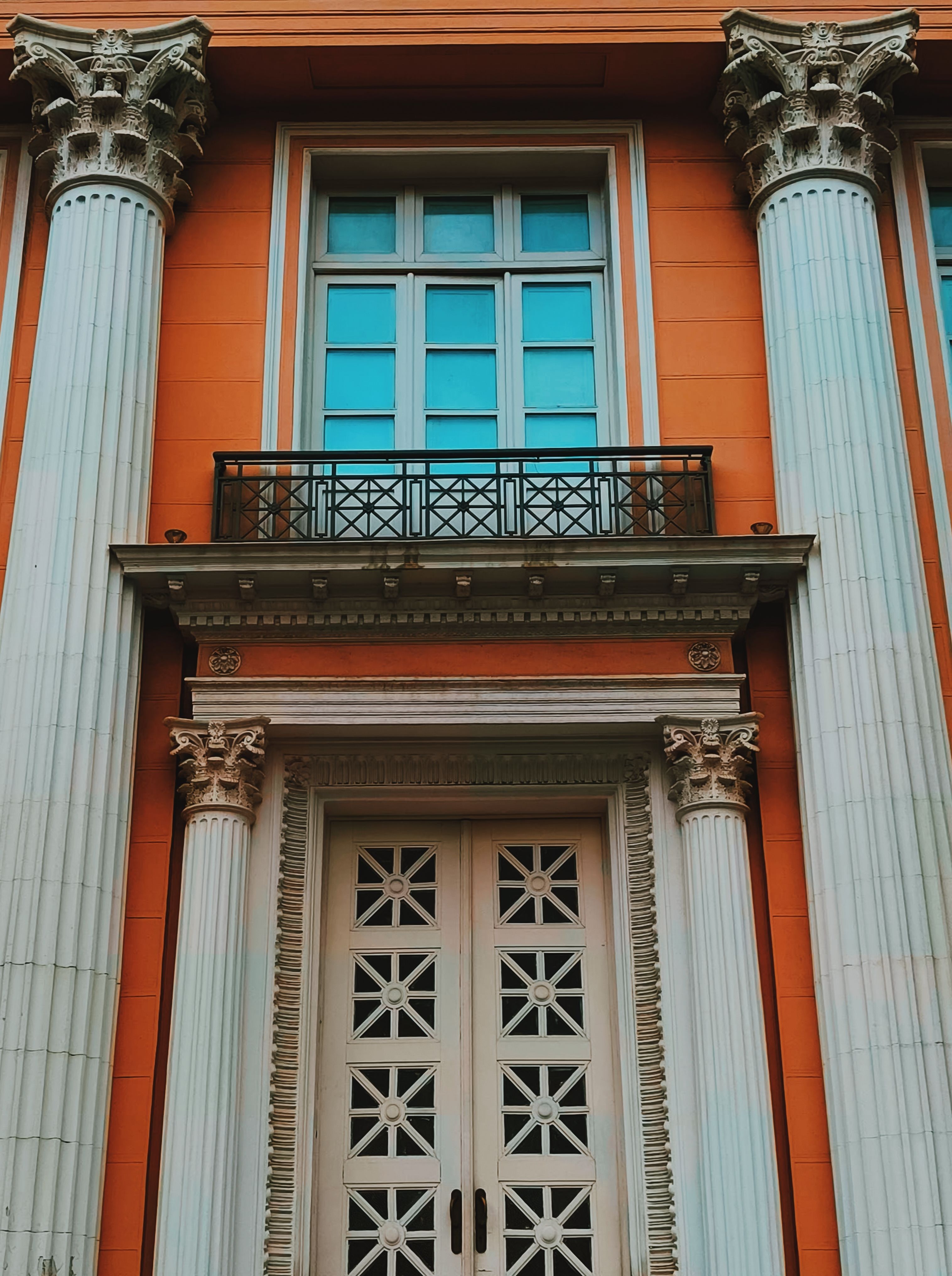 Facade of an Orange Building with Columns · Free Stock Photo