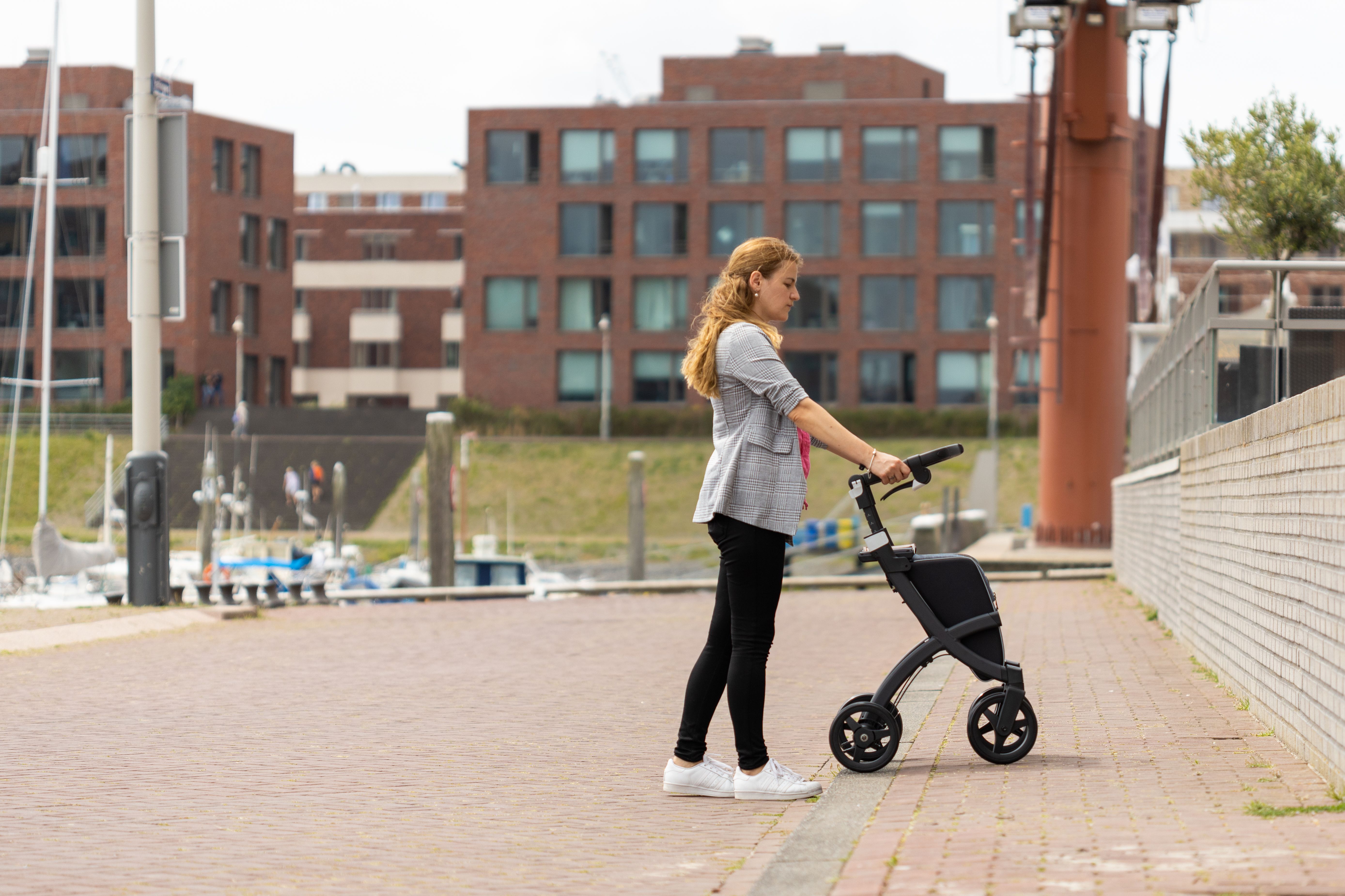 Casual Style Woman Pushing Rollator with Shopping Bag · Free Stock Photo