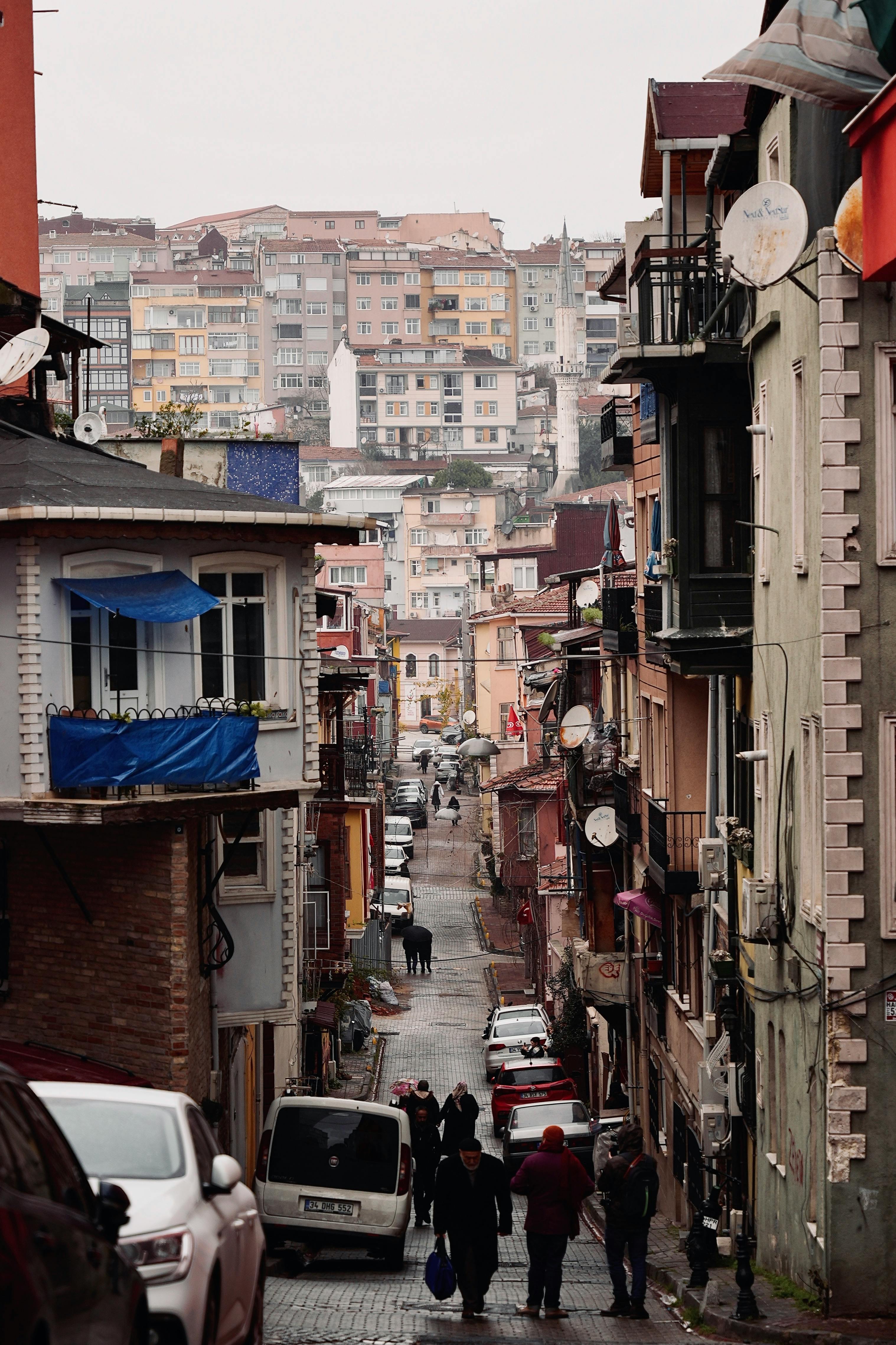 View of Pedestrians Walking in a Narrow Alley between Houses in ...