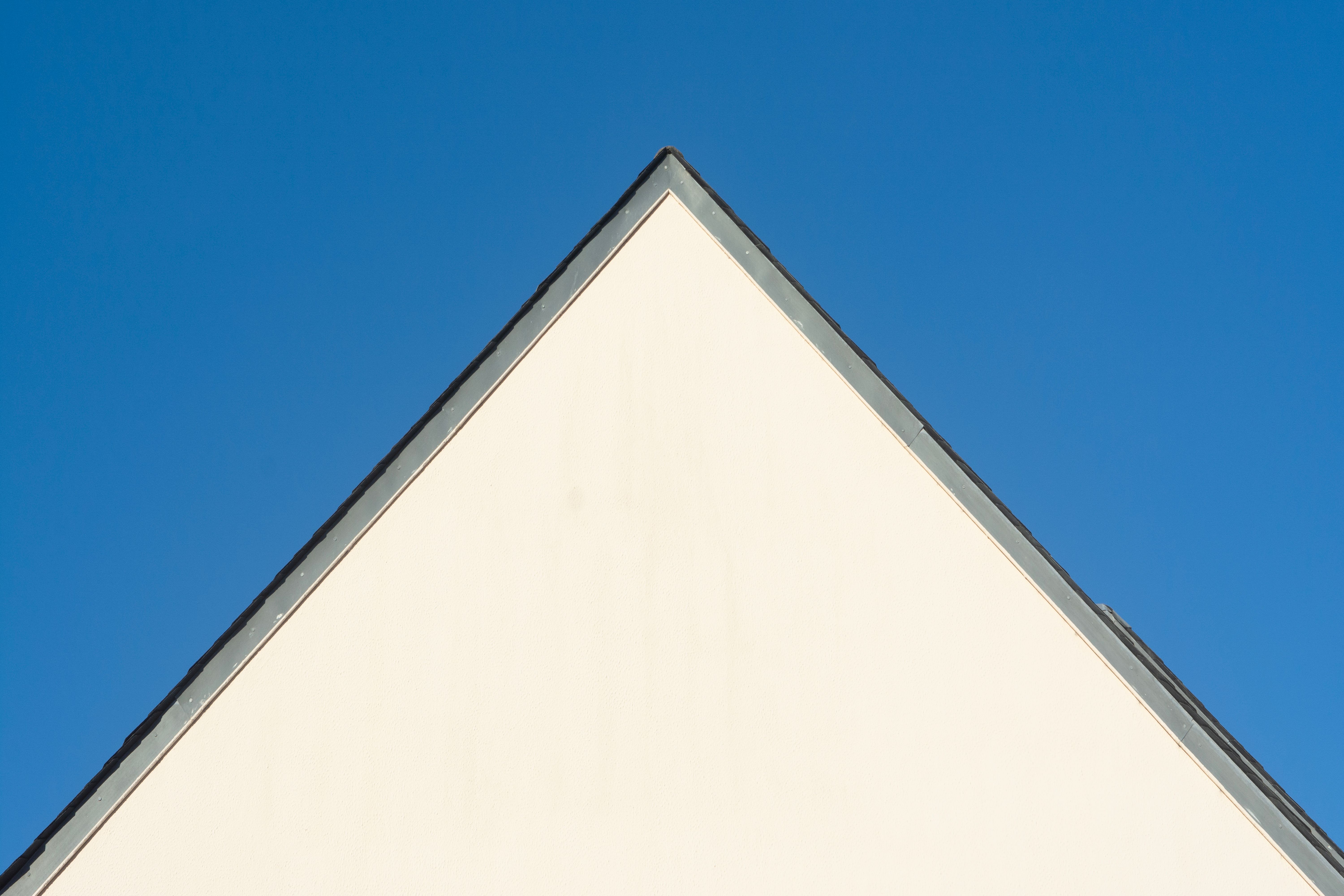 Close-up of the Triangle Facade of a Building against a Clear, Blue Sky ...
