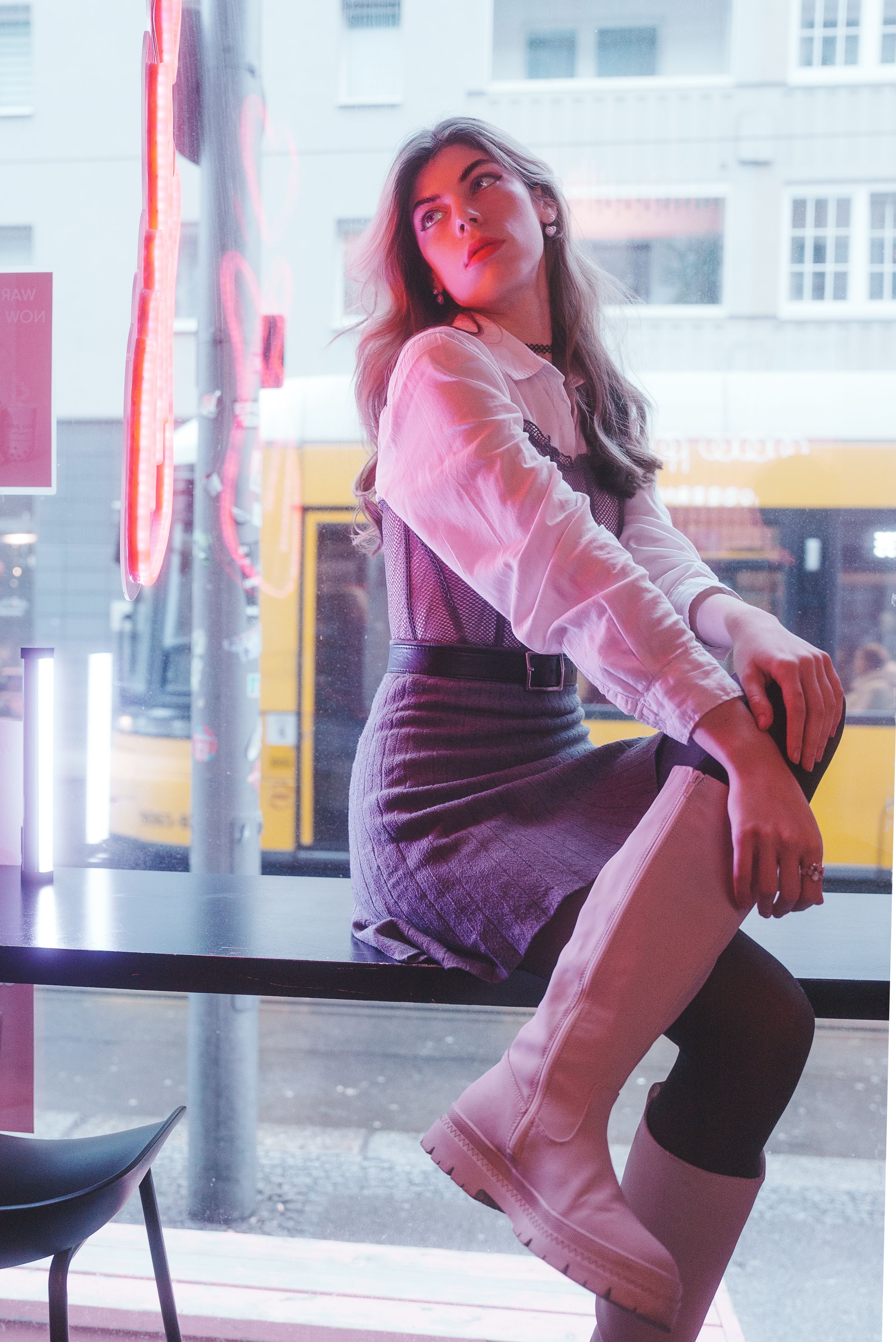 Woman Sitting on the Table with Her Legs Crossed · Free Stock Photo