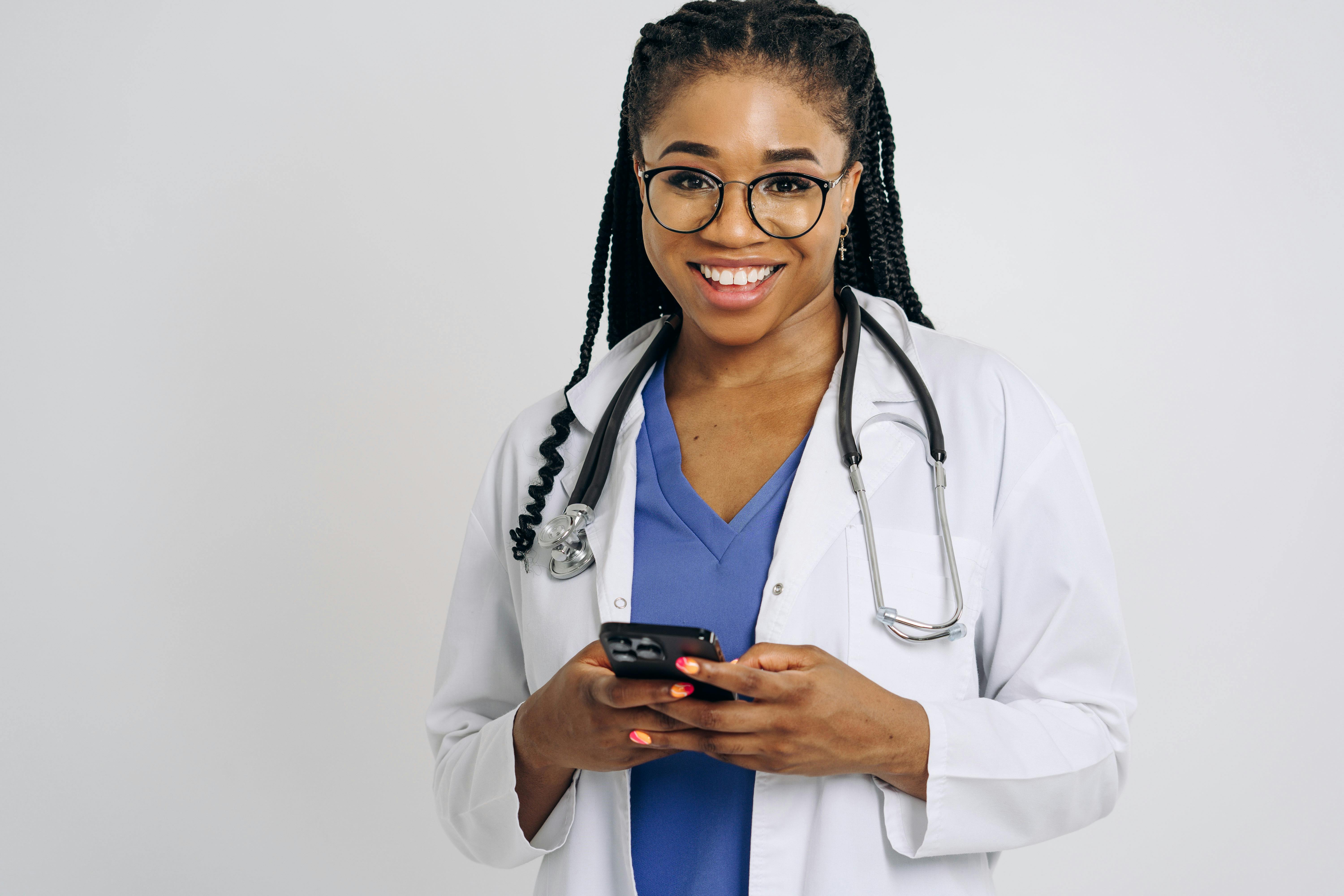 Smiling Doctor Texting · Free Stock Photo