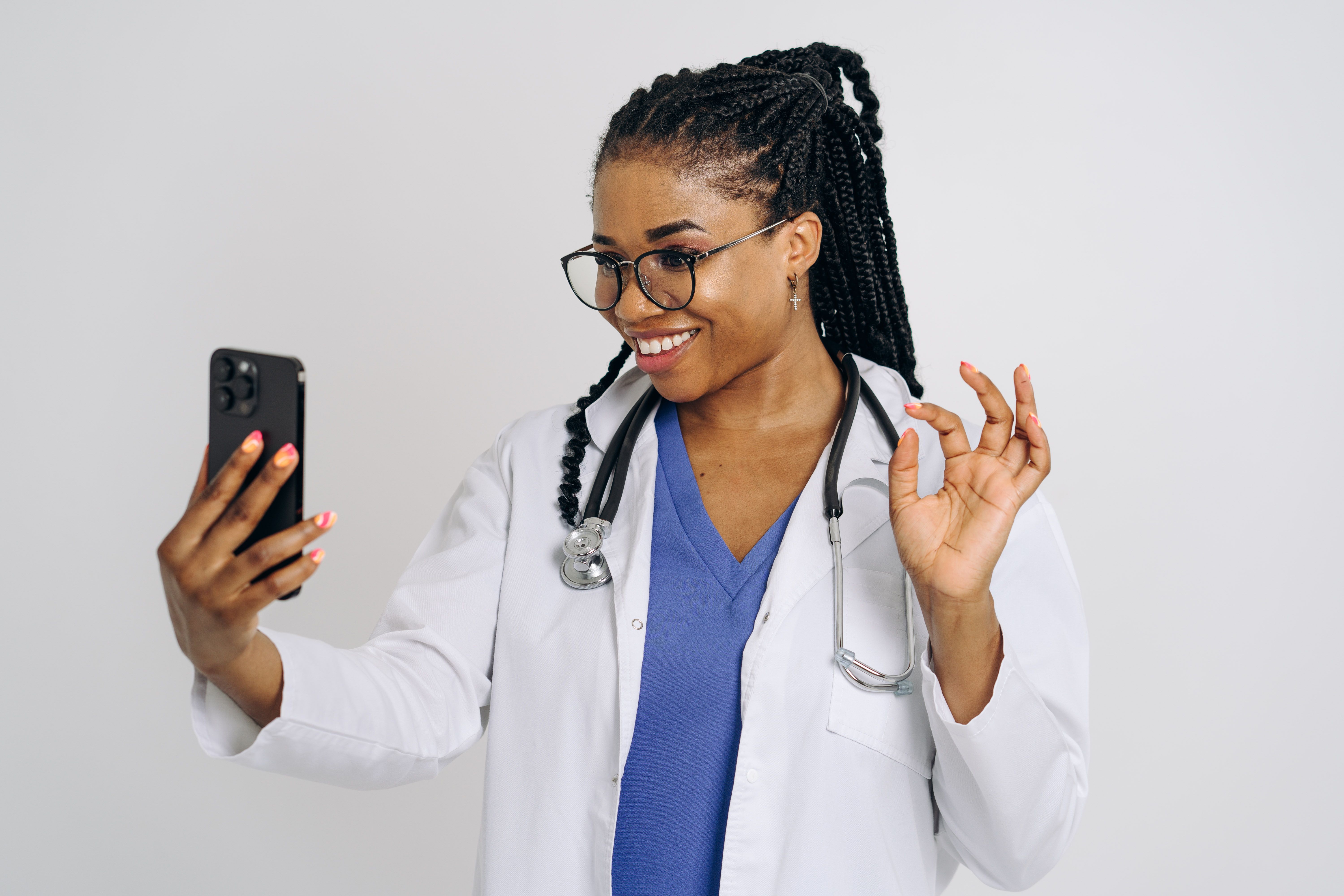 Smiling Doctor Taking Selfie · Free Stock Photo