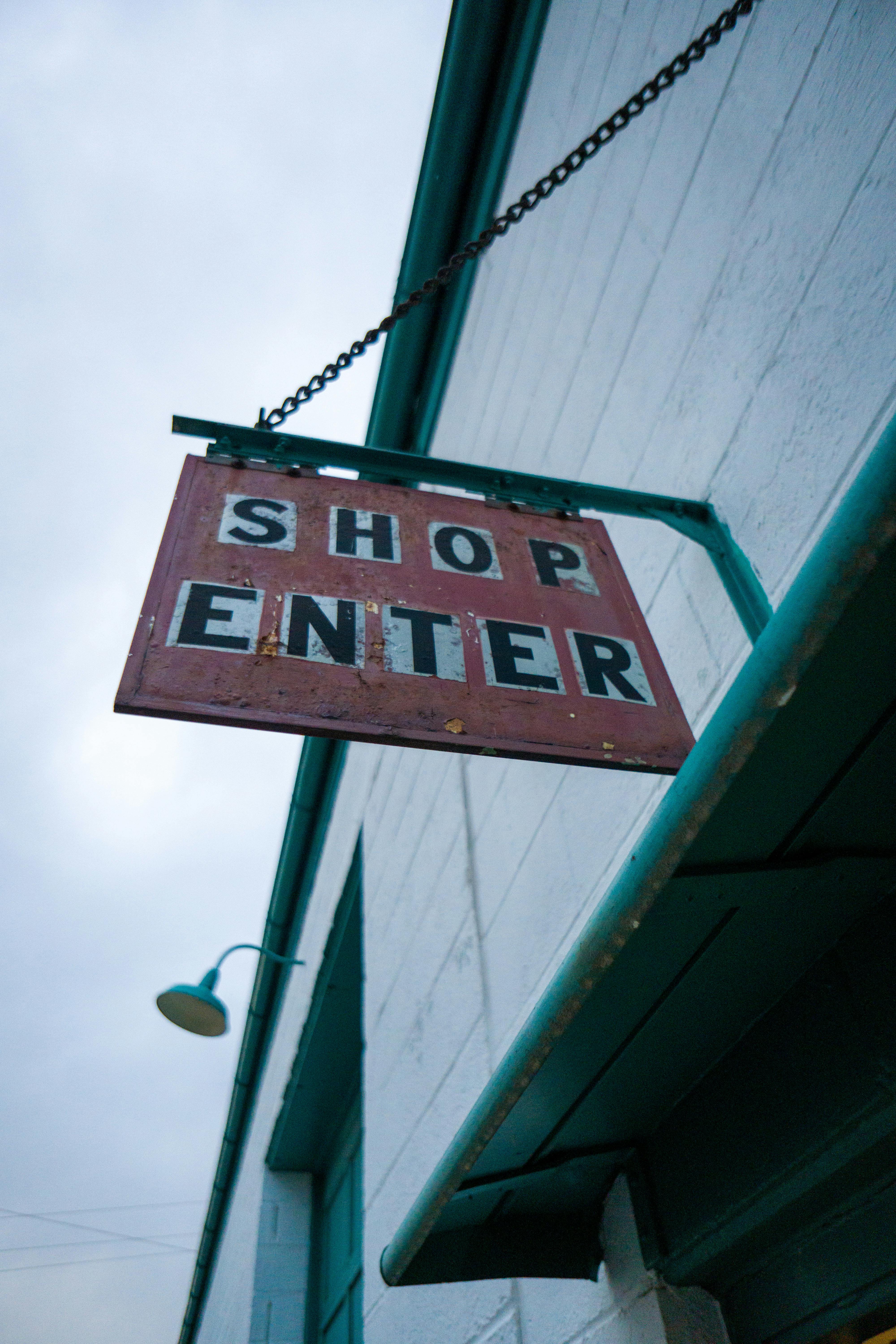 Board with Shop Enter Text on Wall · Free Stock Photo