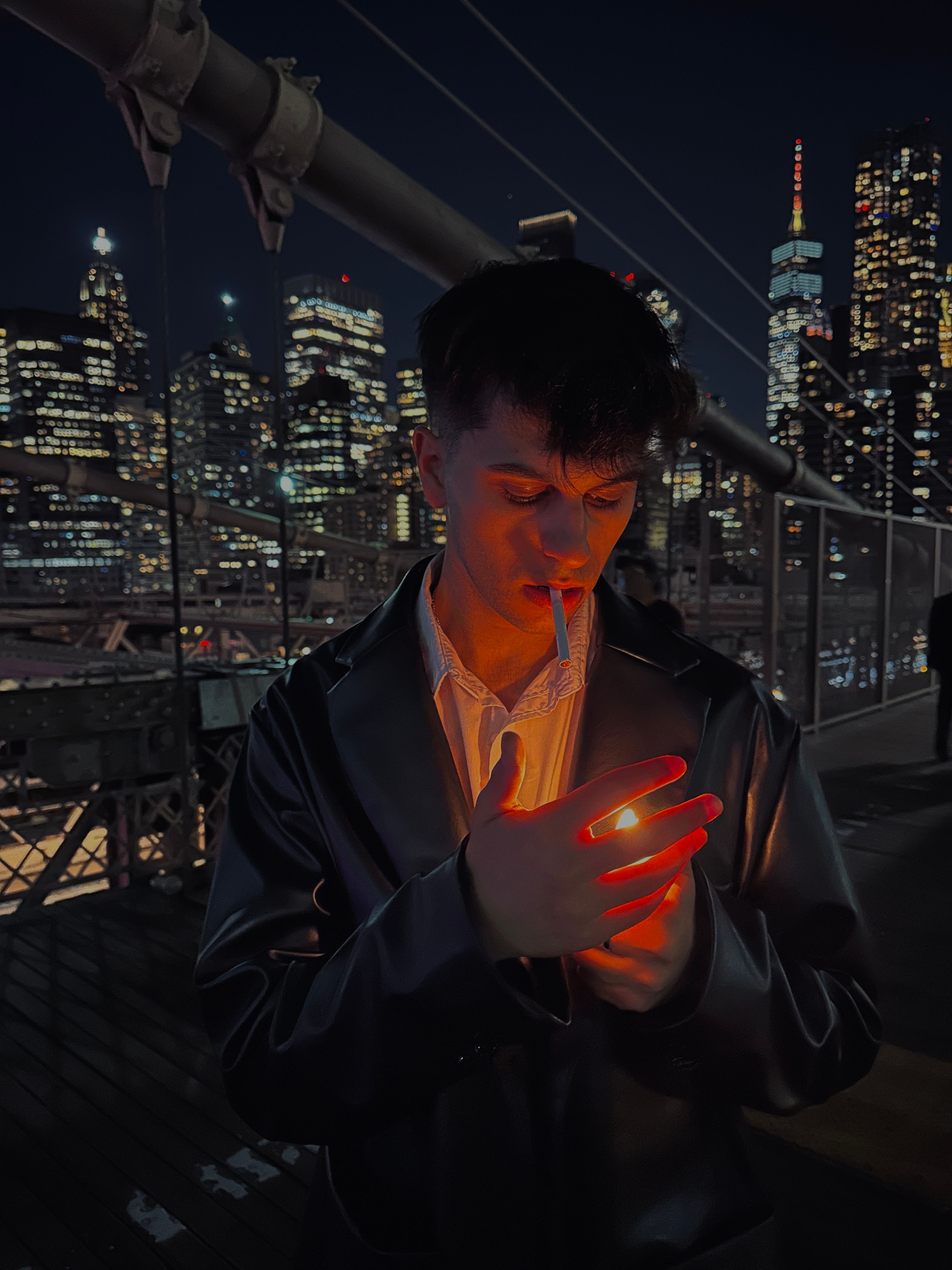 Portrait of Man Lighting Cigarette on Bridge in New York · Free Stock Photo