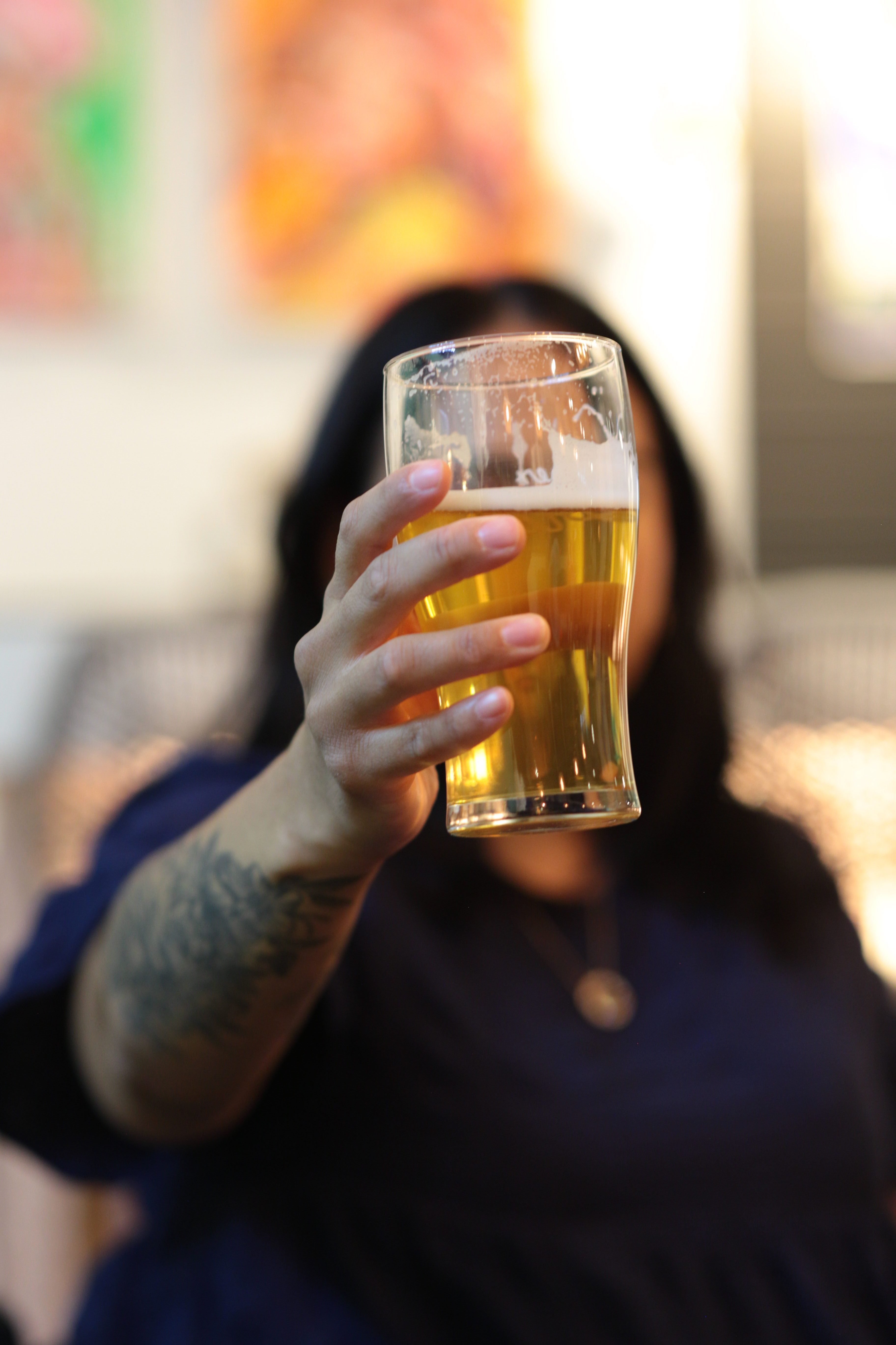 Woman Hand Holding Glass of Beer · Free Stock Photo