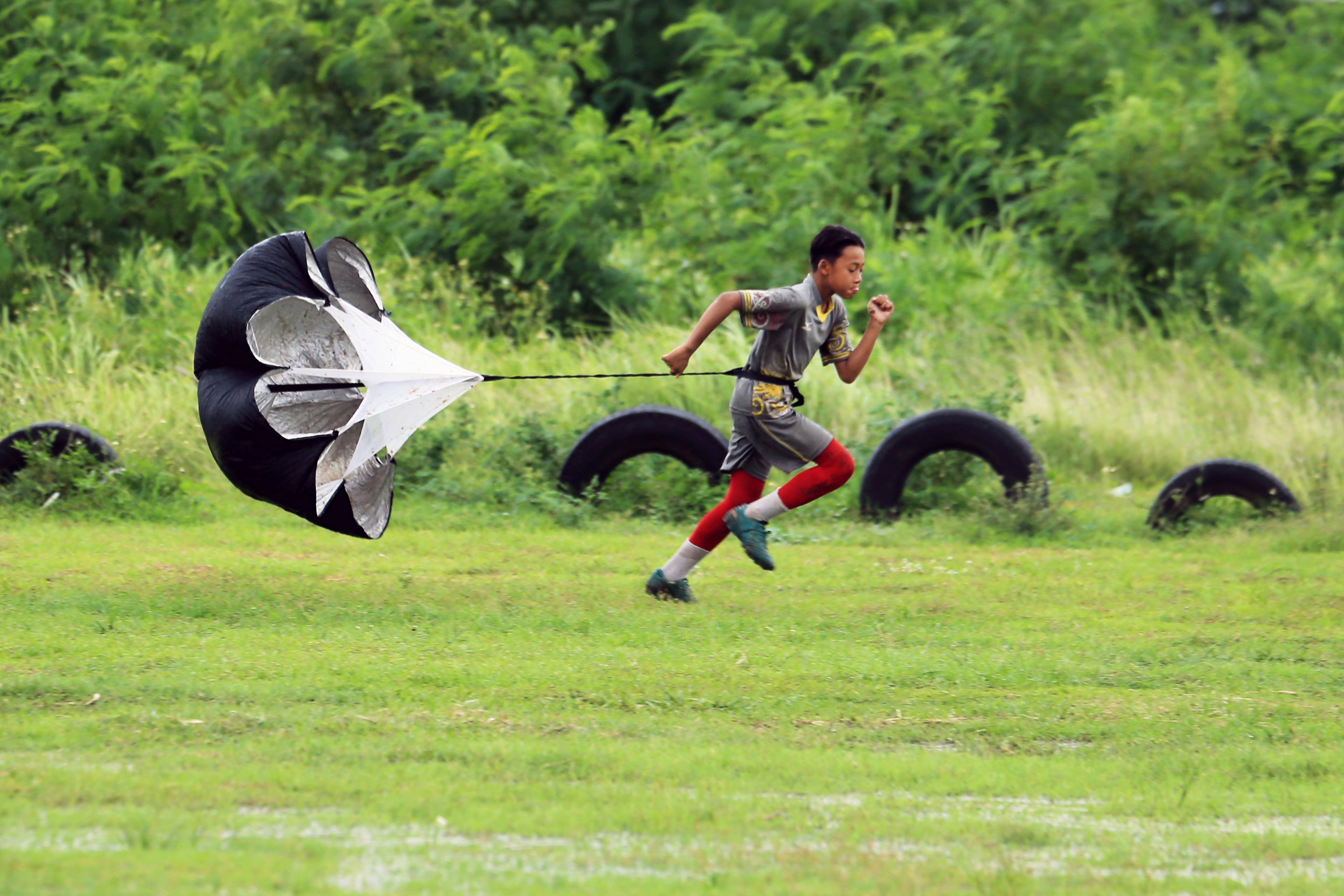 Boy Running with a Parachute · Free Stock Photo