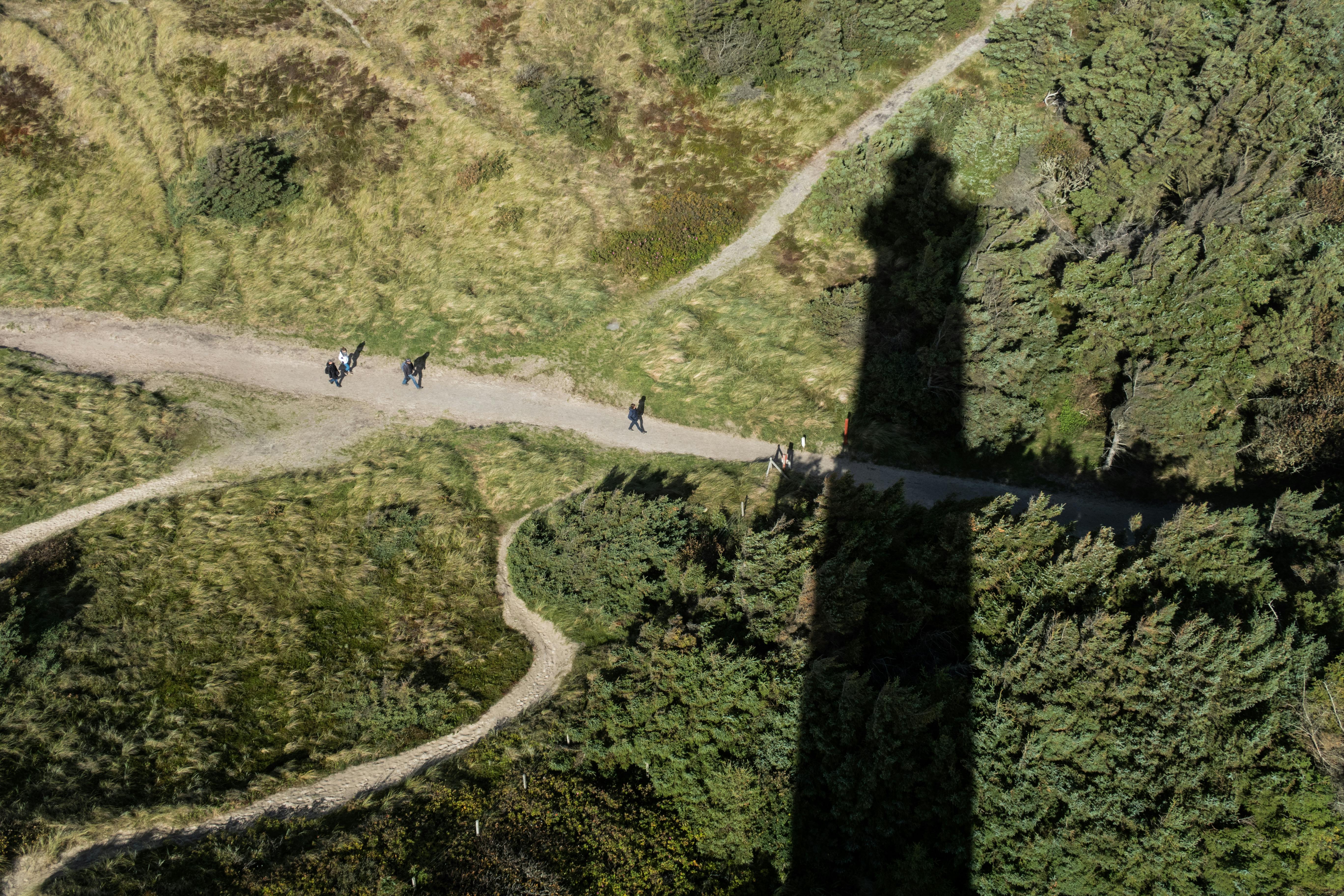 Aerial View of a Lighthouse Casting Shadow on the Ground · Free Stock Photo