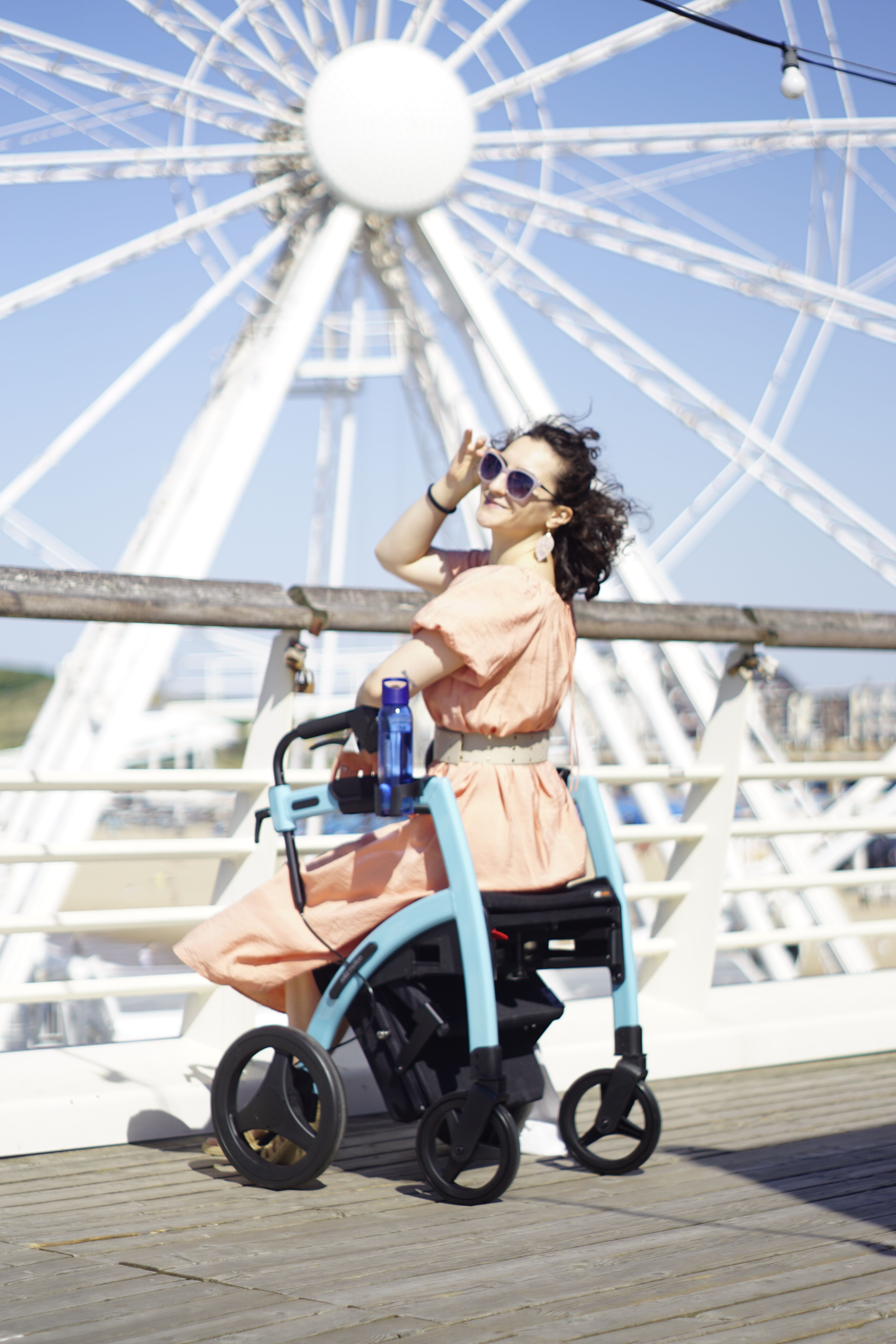 Woman in a Dress Sitting on a Rollator Walking Aid on a Pier · Free ...