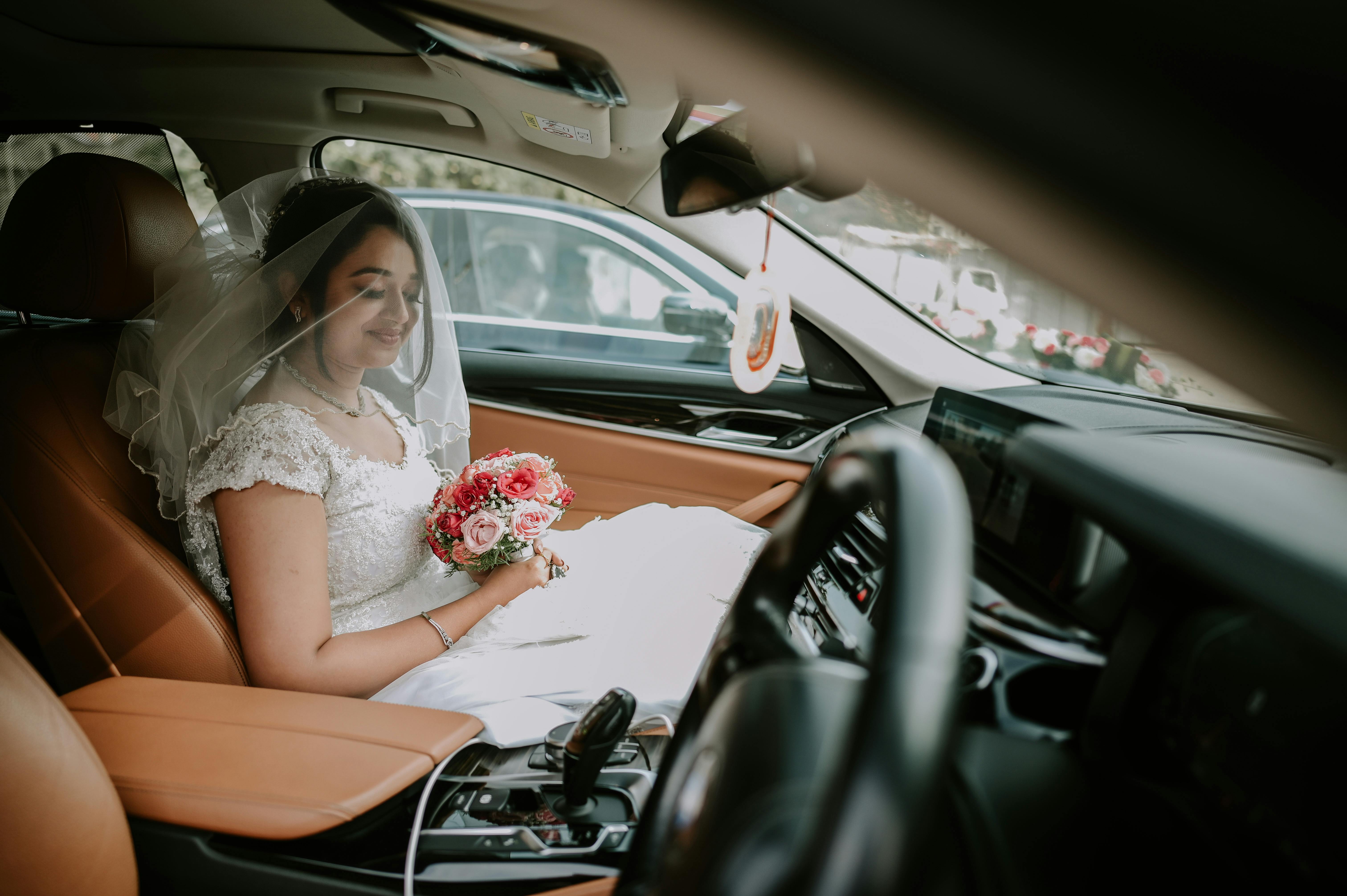 Smiling Bride Sitting in Car · Free Stock Photo