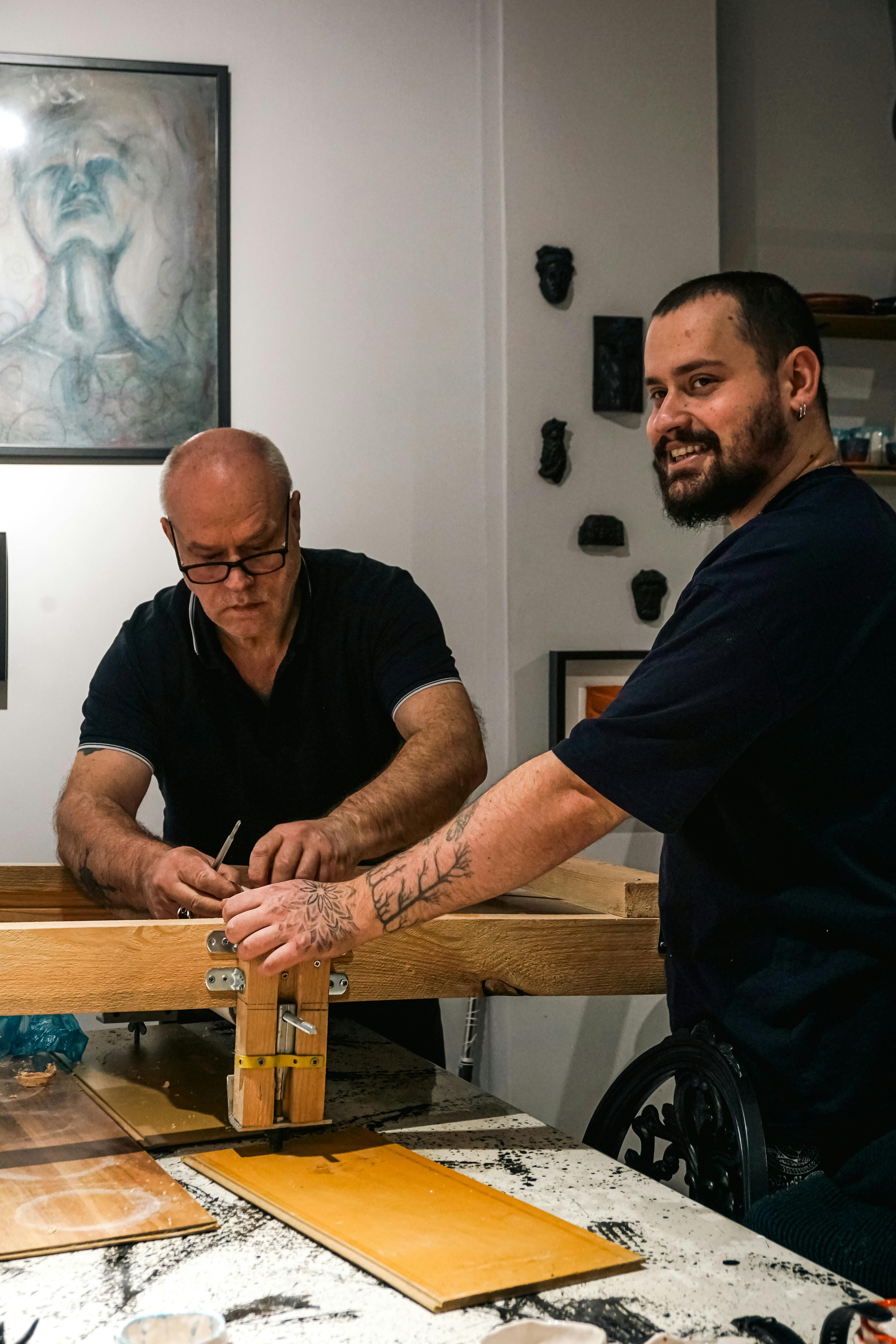 Carpenters Standing by Table and Working · Free Stock Photo