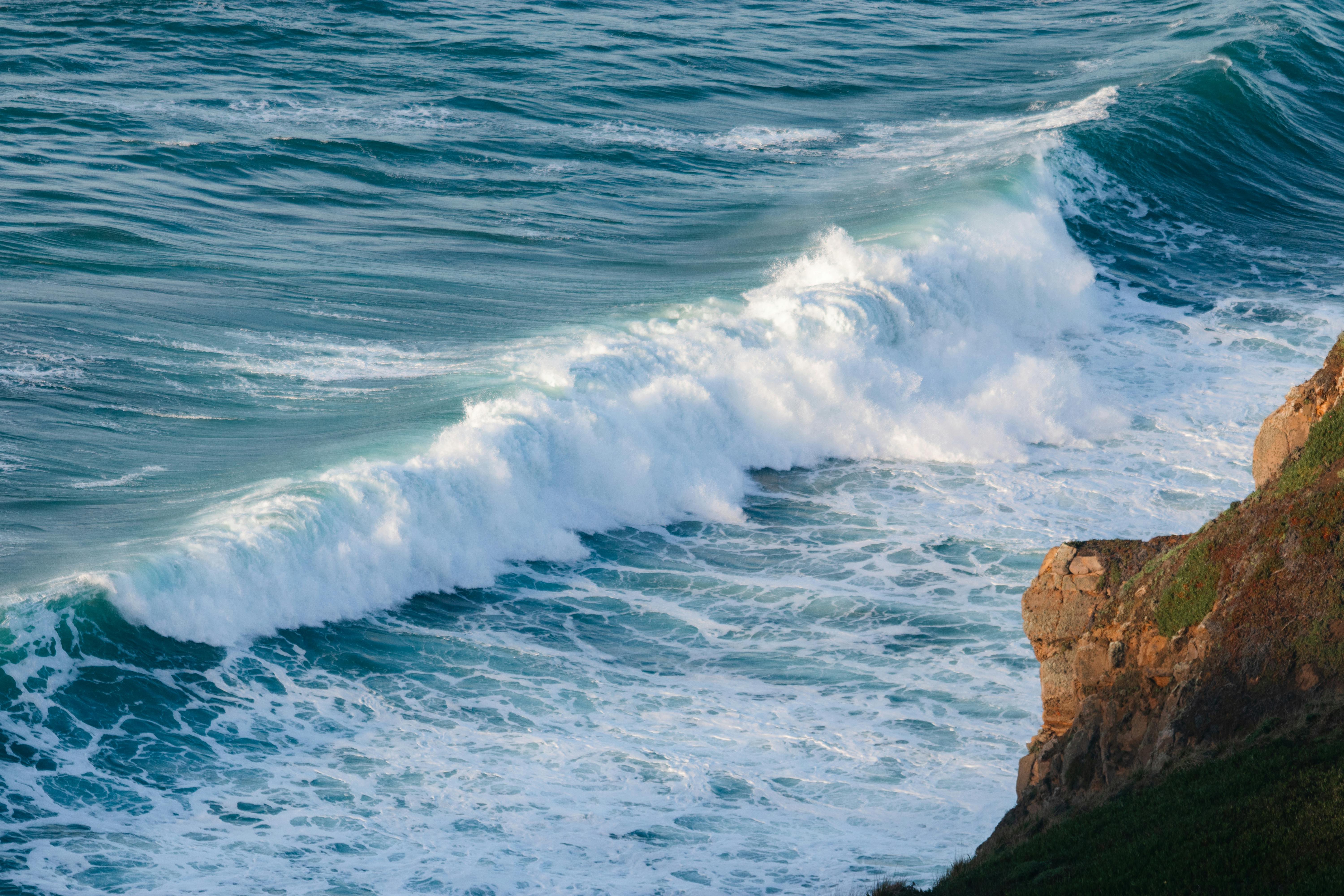 Ocean Waves Crashing on Rocks during Sunset · Free Stock Photo