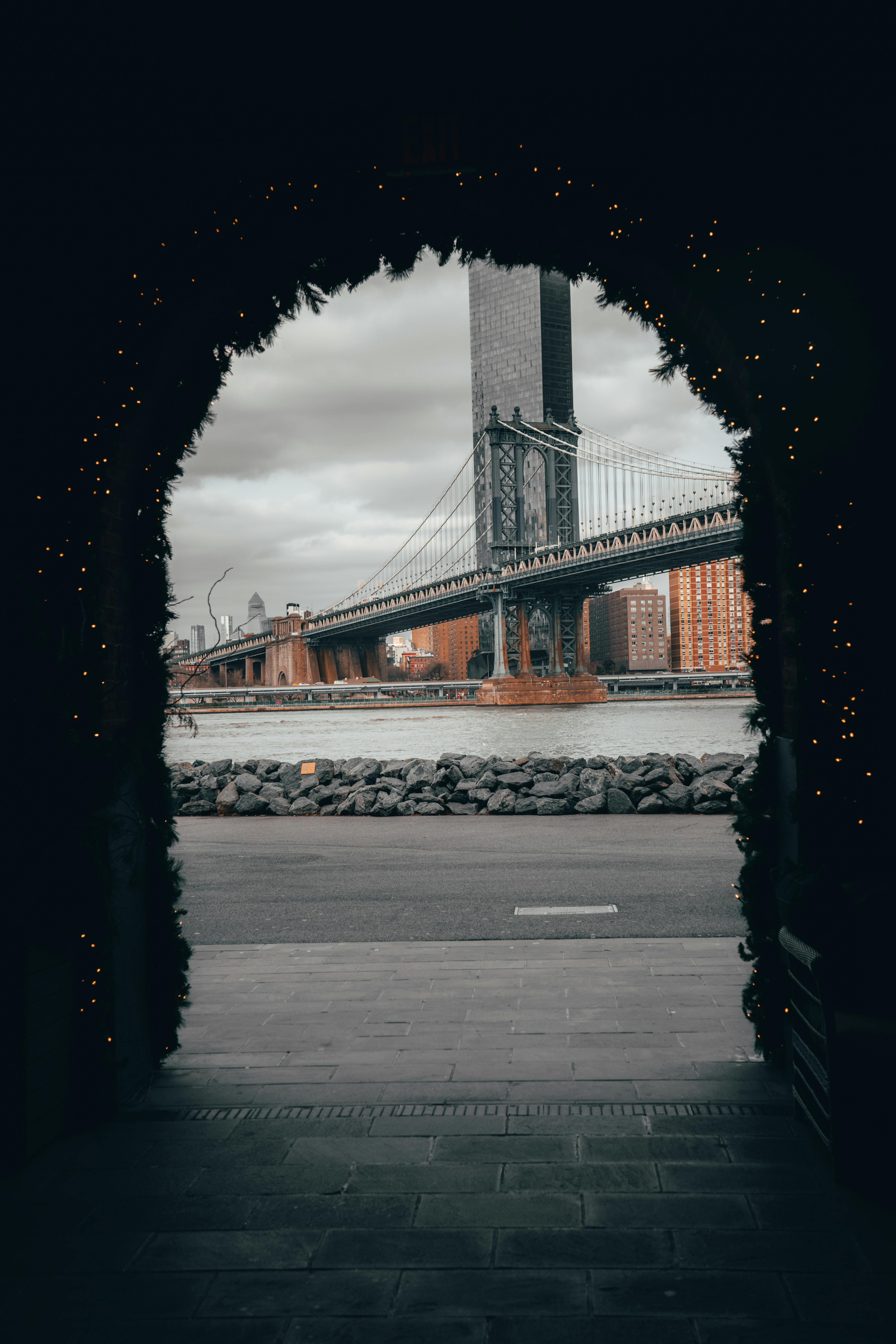 Brooklyn Bridge behind Arch with Christmas Garland · Free Stock Photo