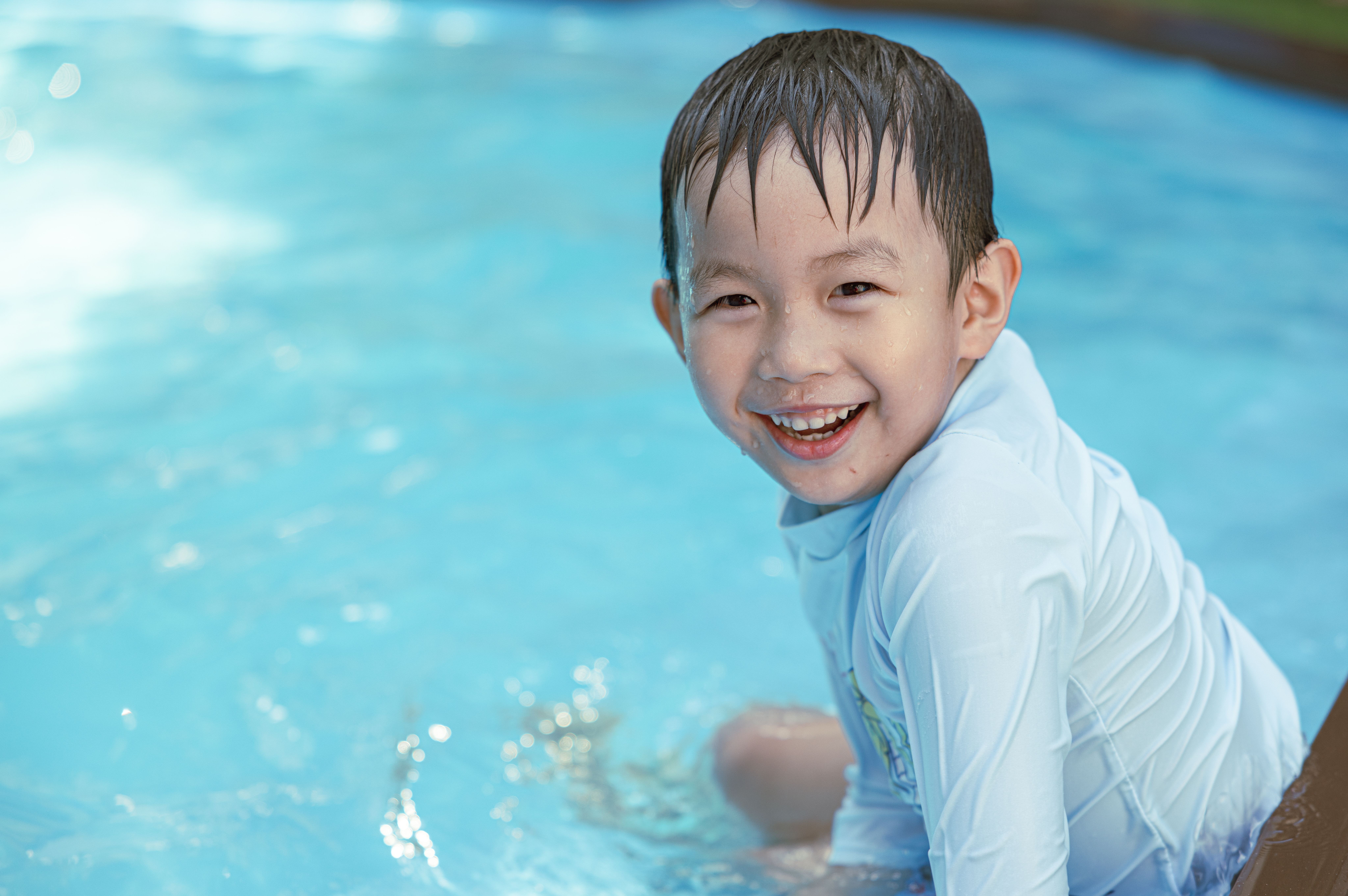 Smiling Boy Sitting in Water · Free Stock Photo