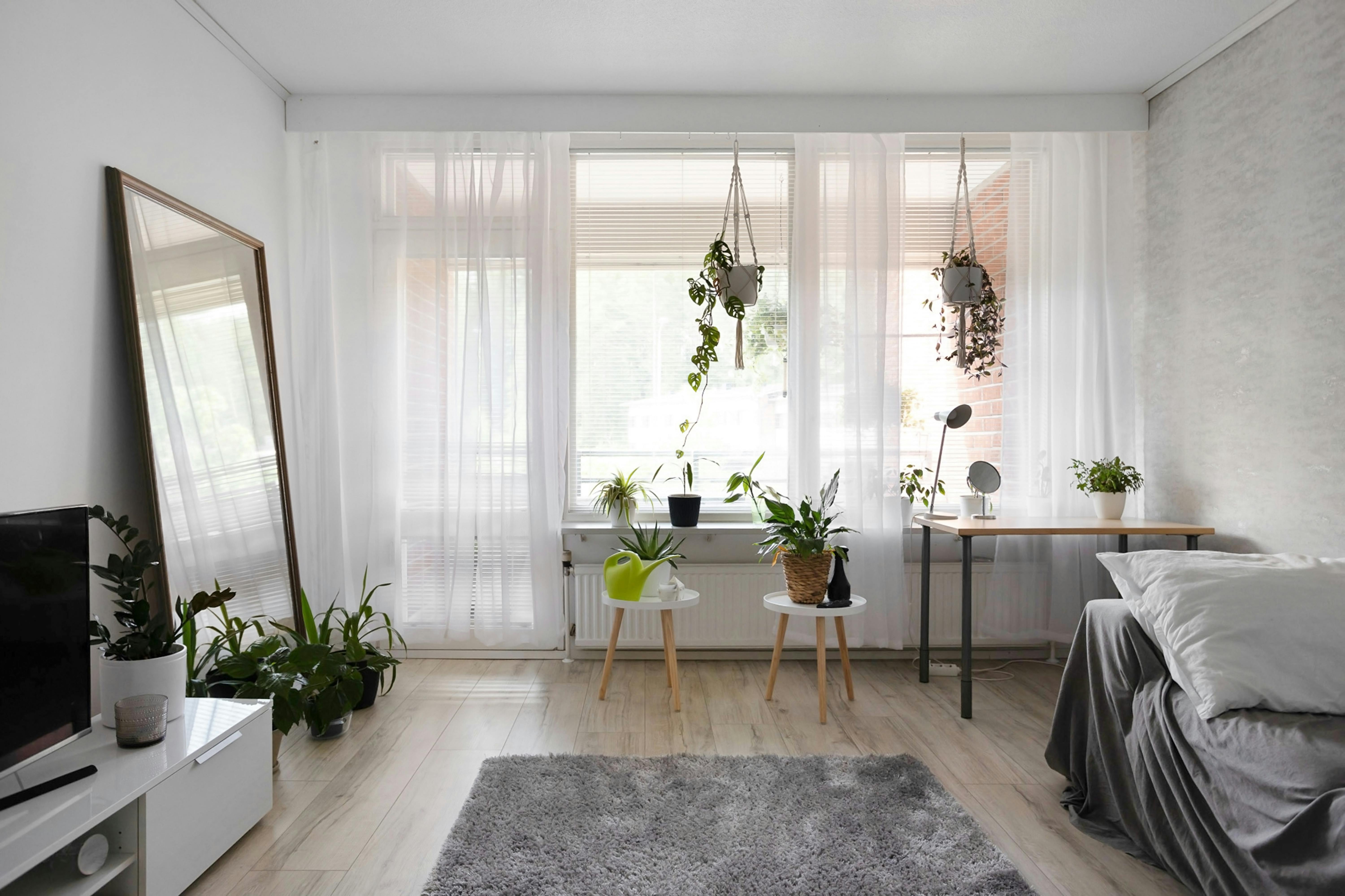 Young woman inside modern stylish room with two tier layout and floral ...