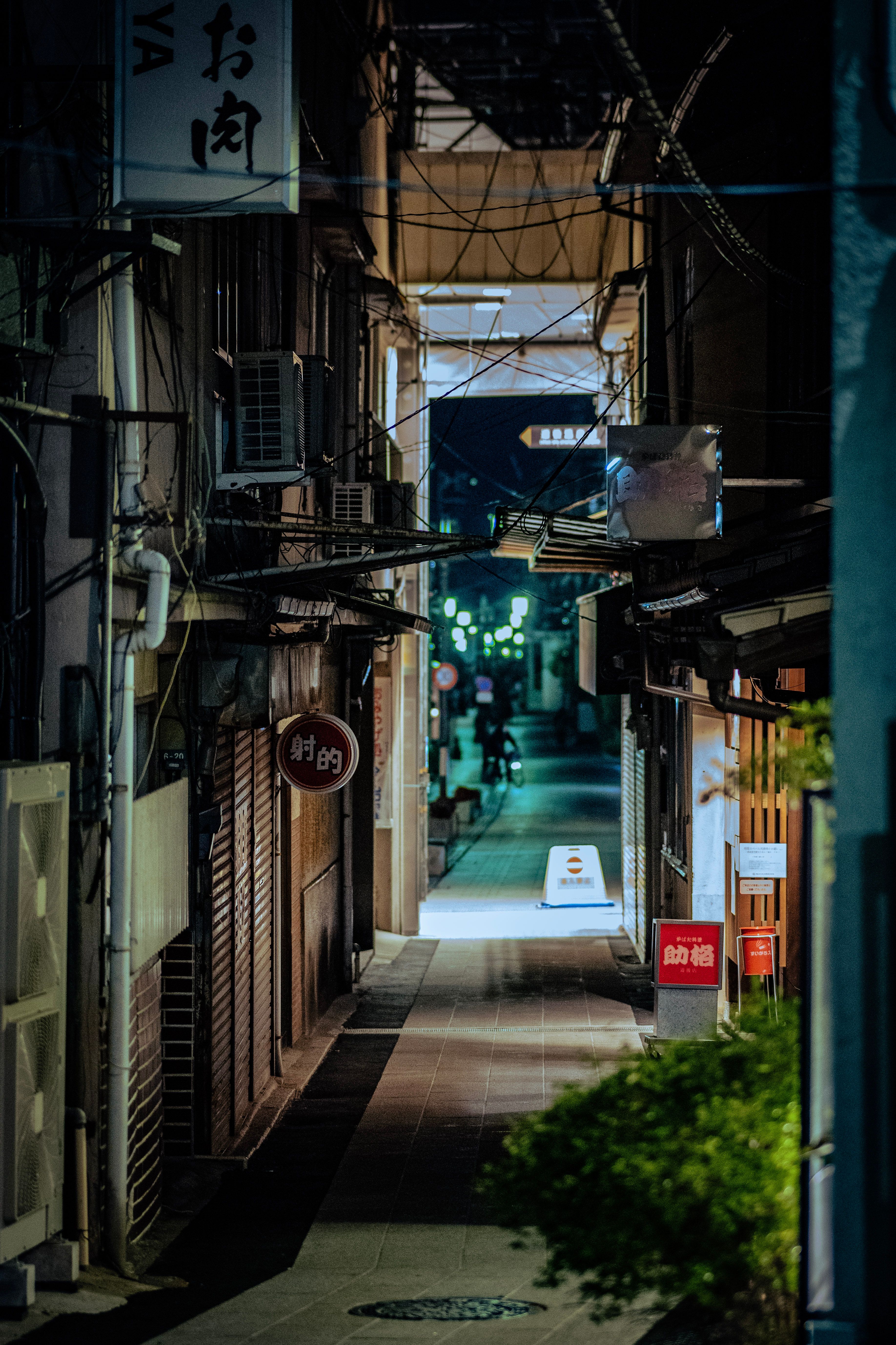 Person Walking on Concrete Alleyway at Night T · Free Stock Photo