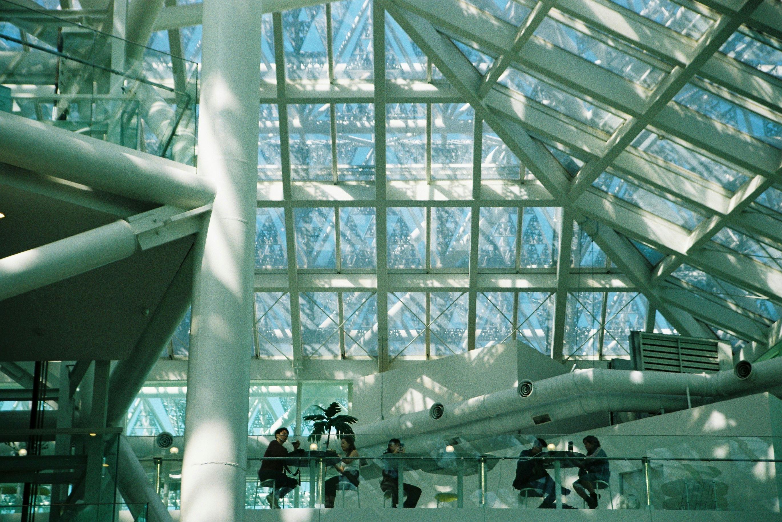 People Walking Inside Glass Building · Free Stock Photo