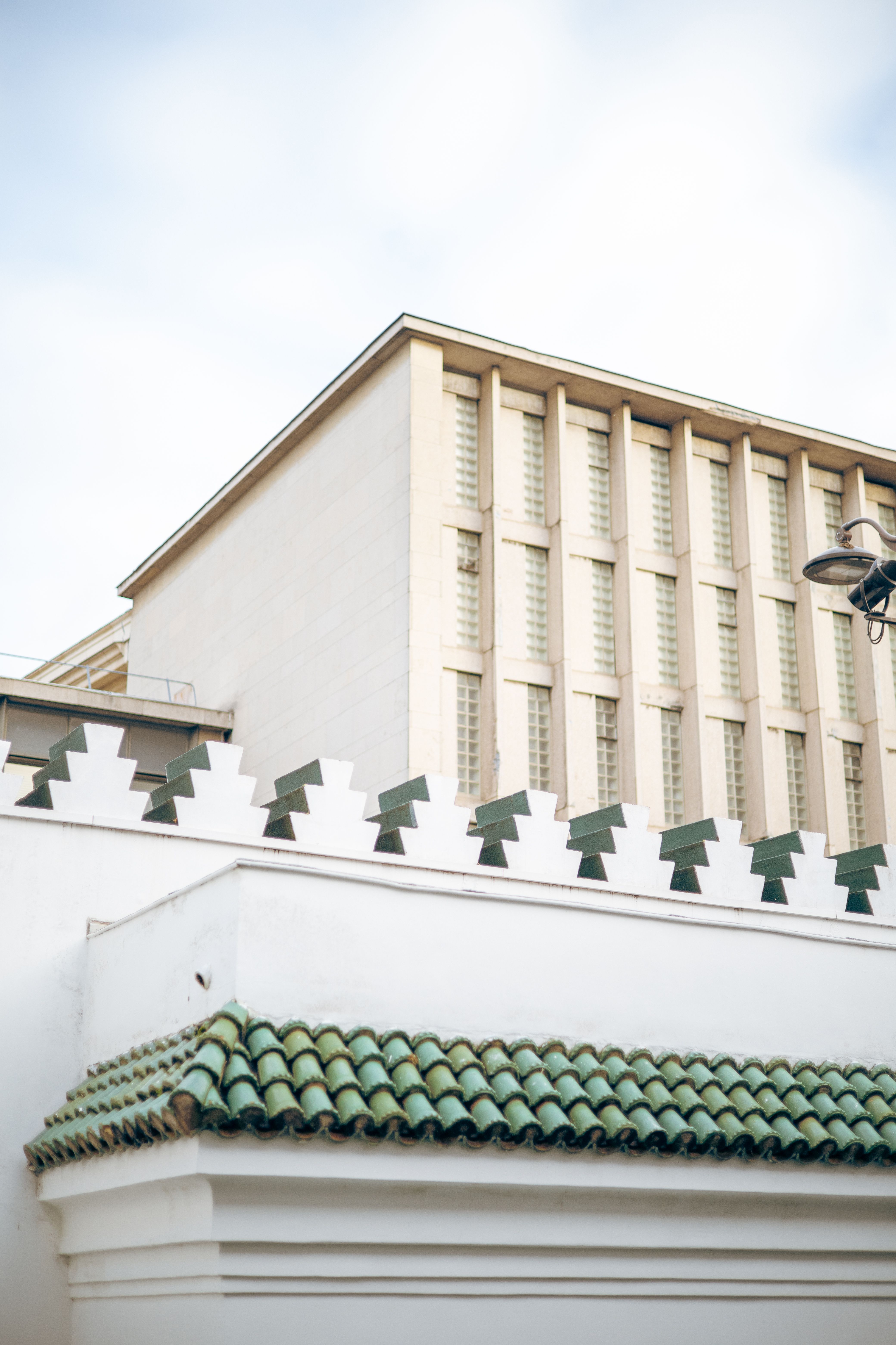 White Surrounding Wall and a Facade of a Building · Free Stock Photo