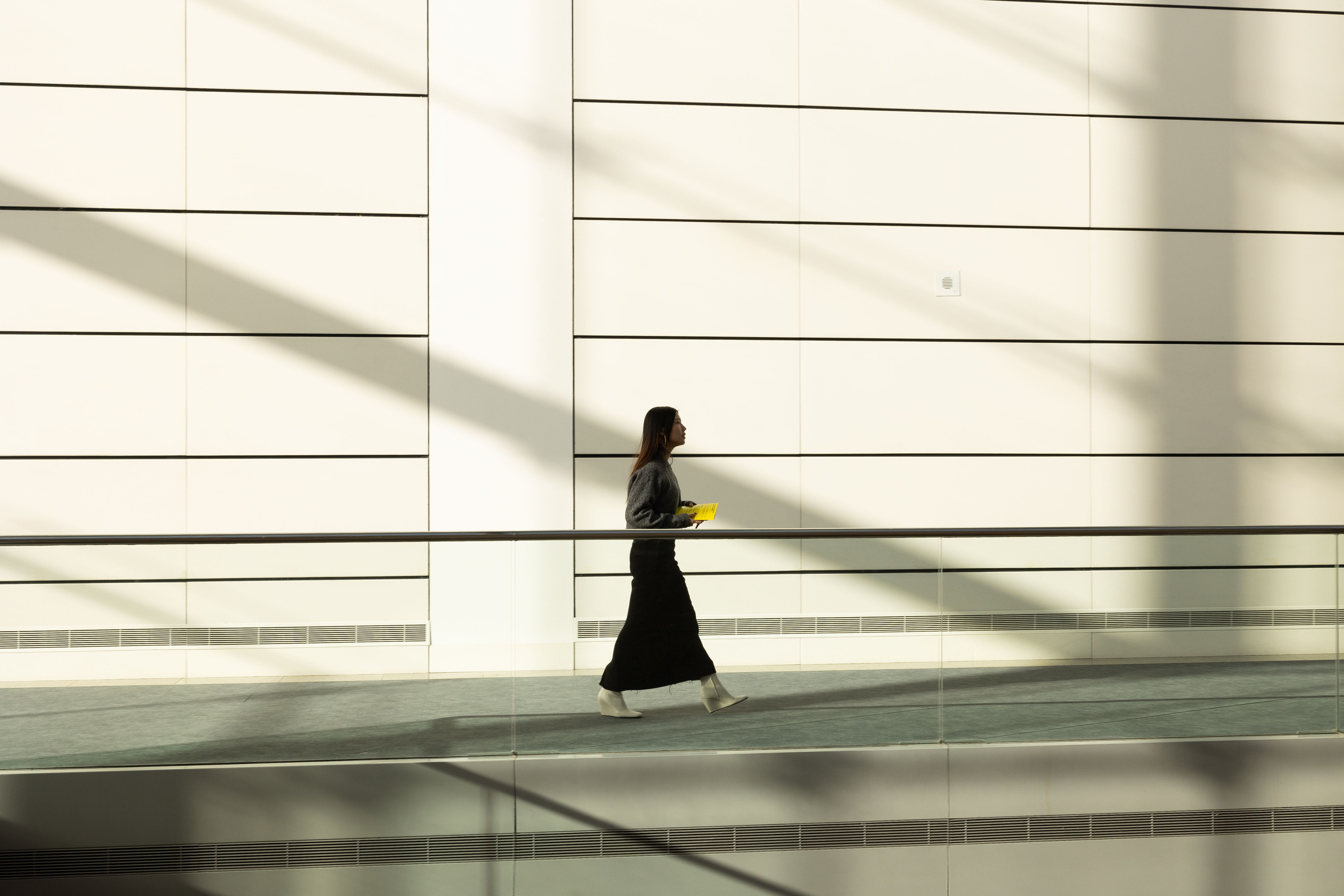 Woman Walking on a Street in Sunlight · Free Stock Photo