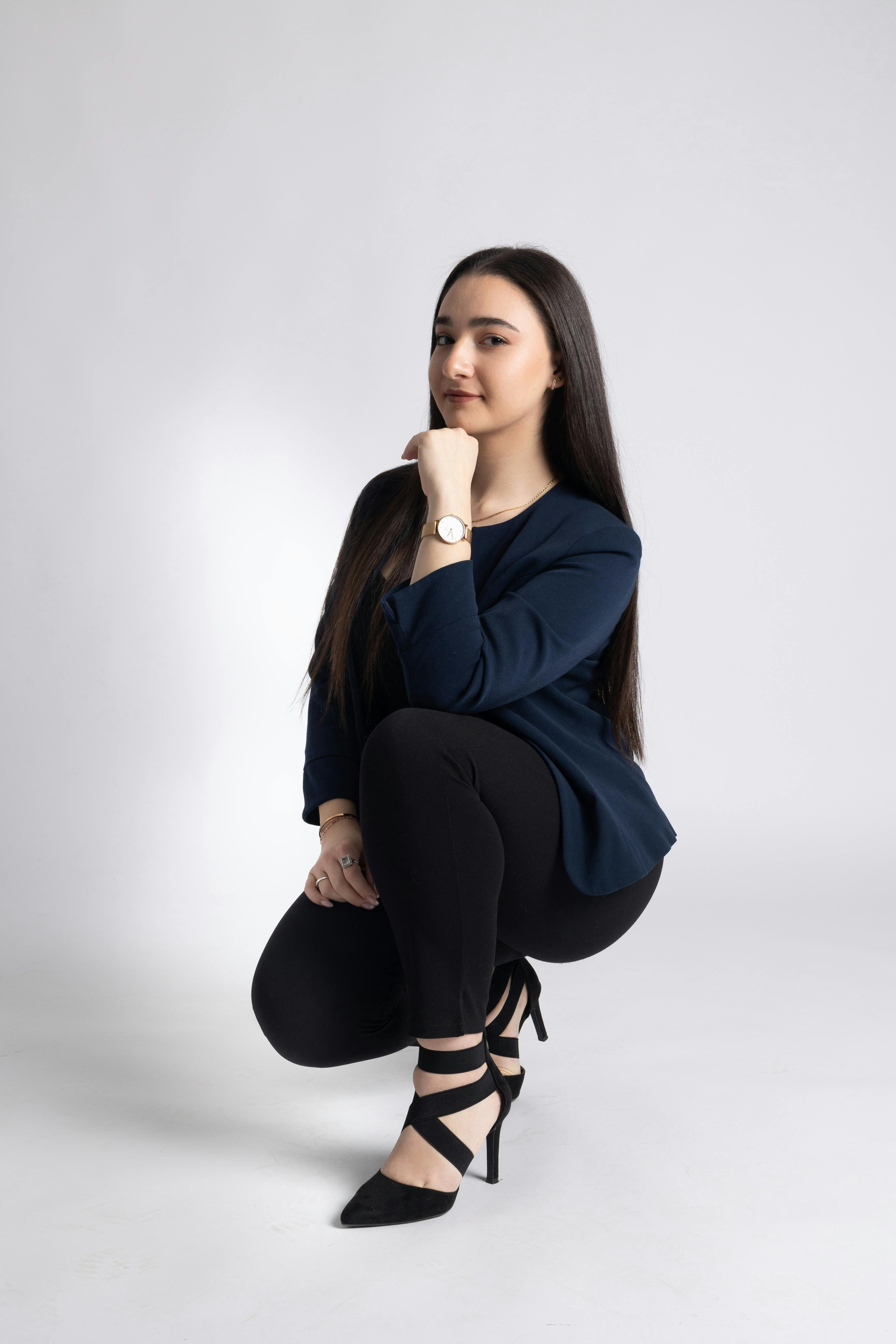 Woman Crouching in High Heels · Free Stock Photo