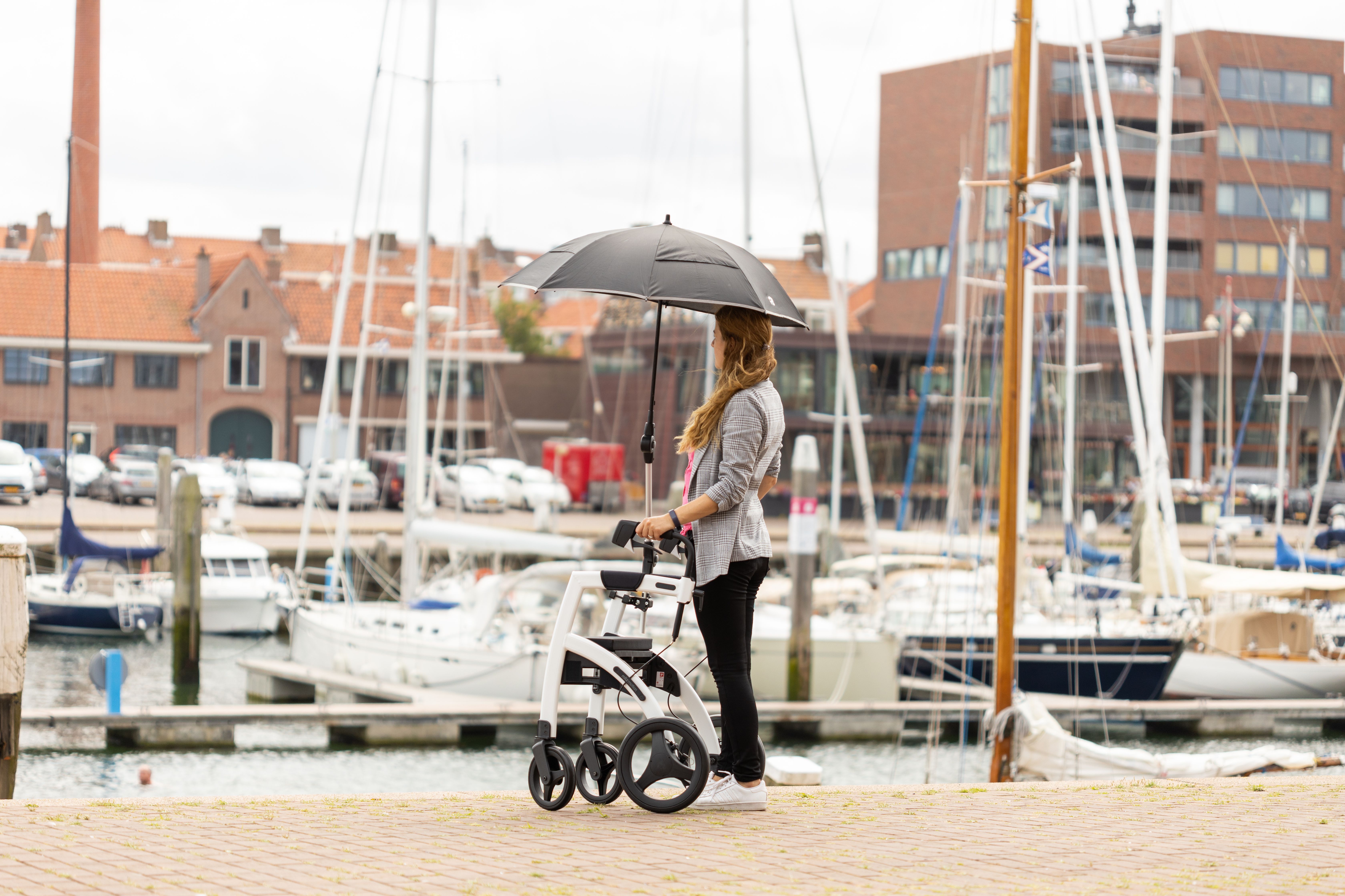 Woman Using Mobility Aid with Umbrella · Free Stock Photo