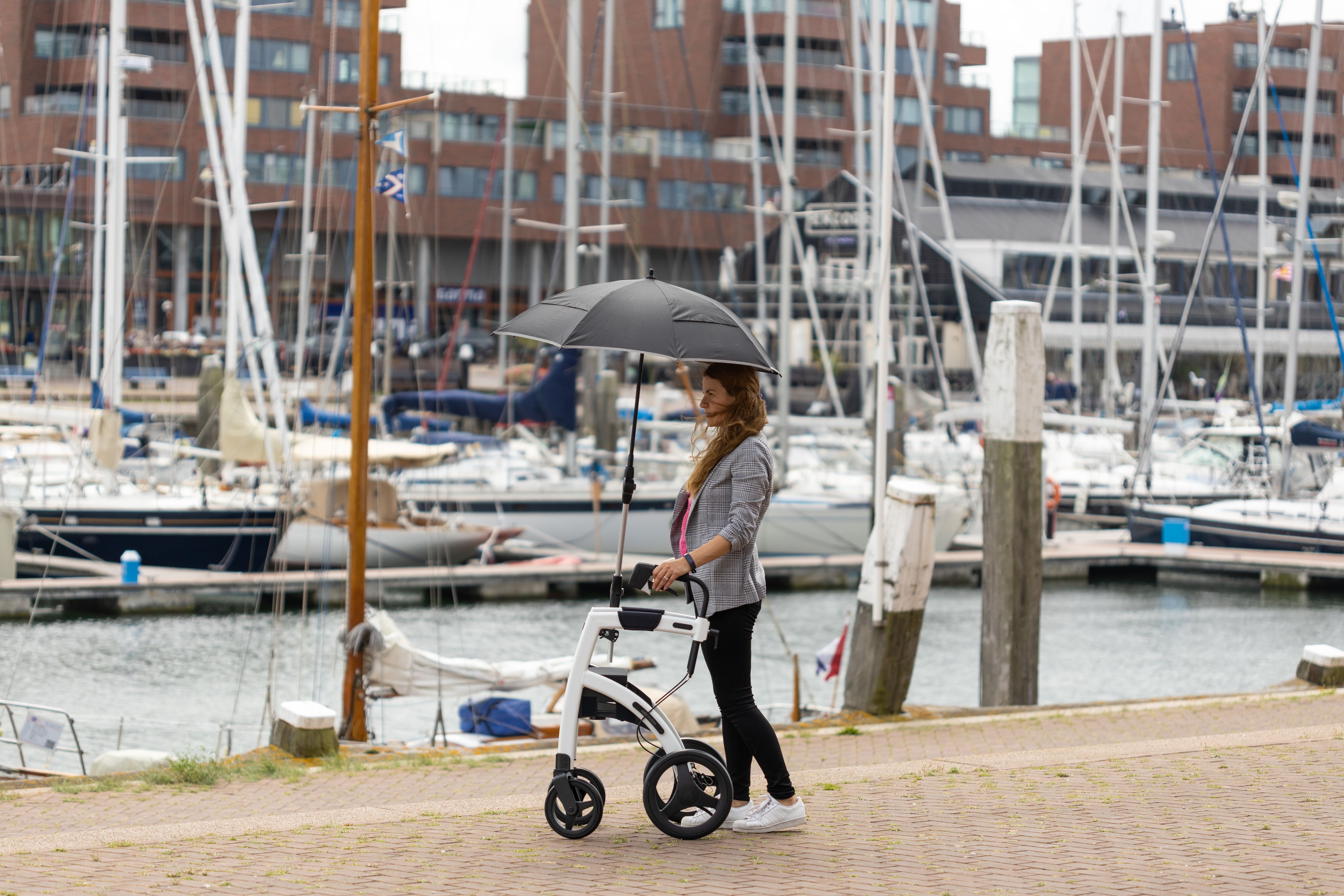 Woman standing with a rollator walker at a dock · Free Stock Photo