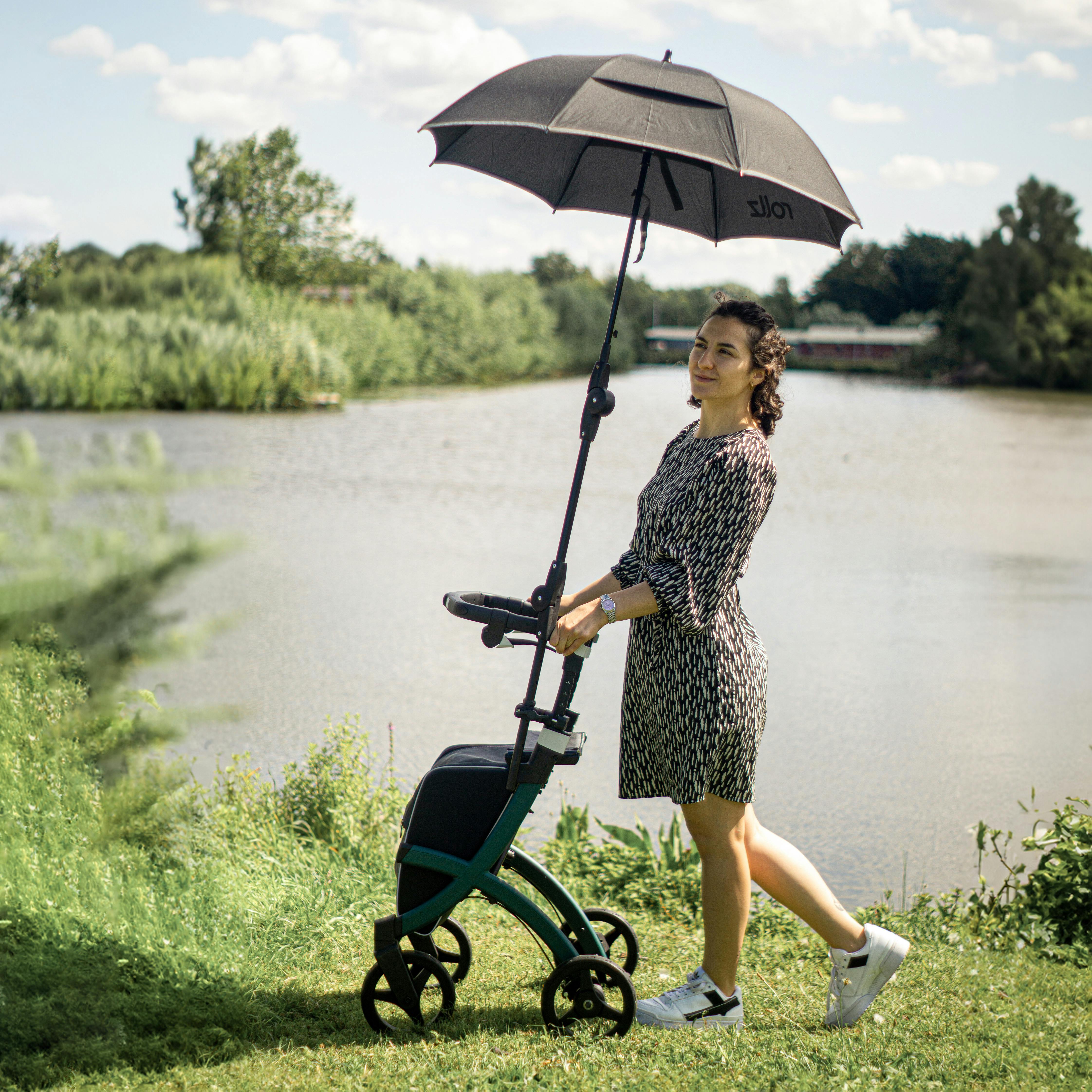 Woman Walking with Walker with Umbrella · Free Stock Photo