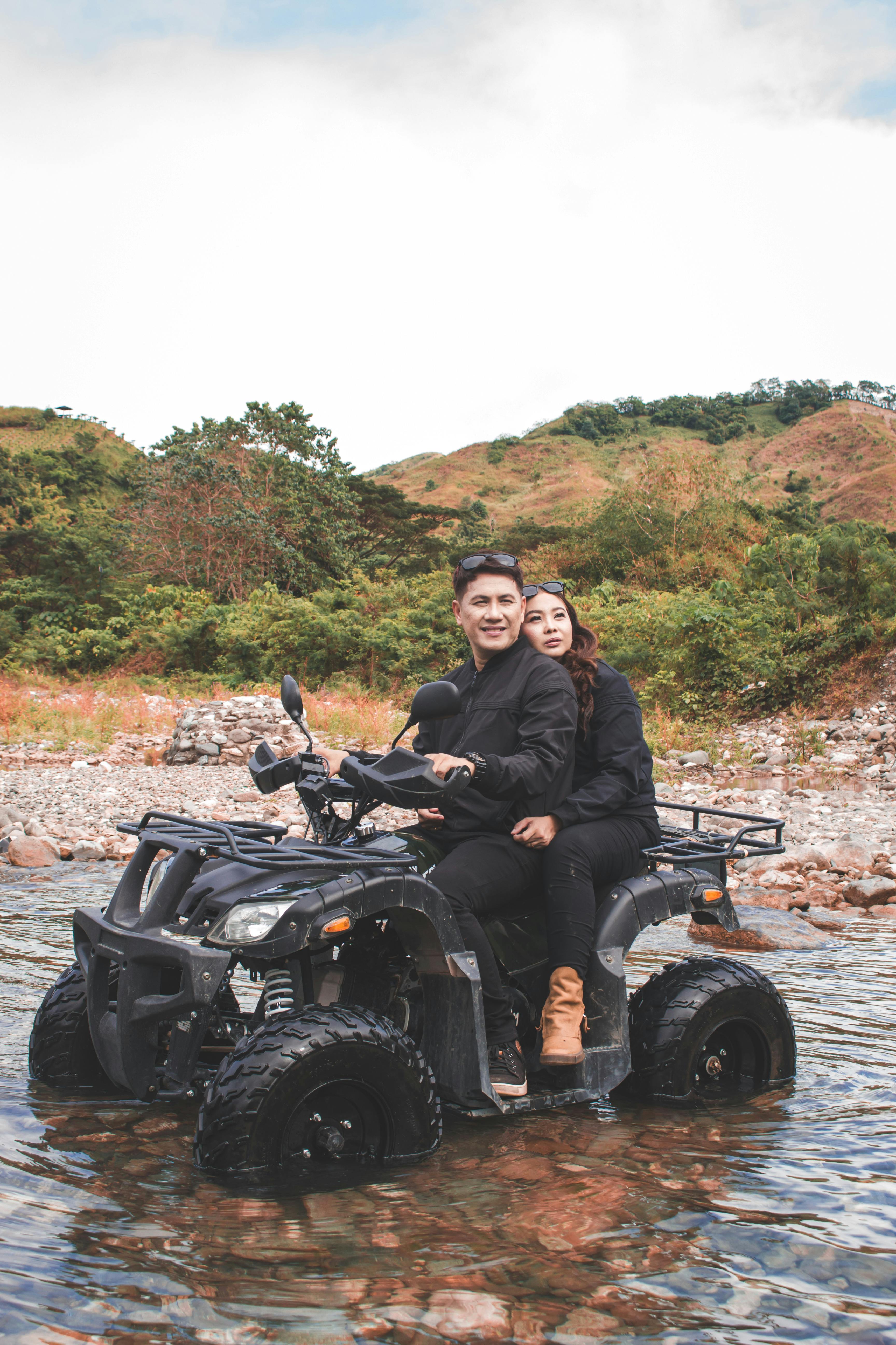 Couple on Quad in Water on Lakeshore · Free Stock Photo