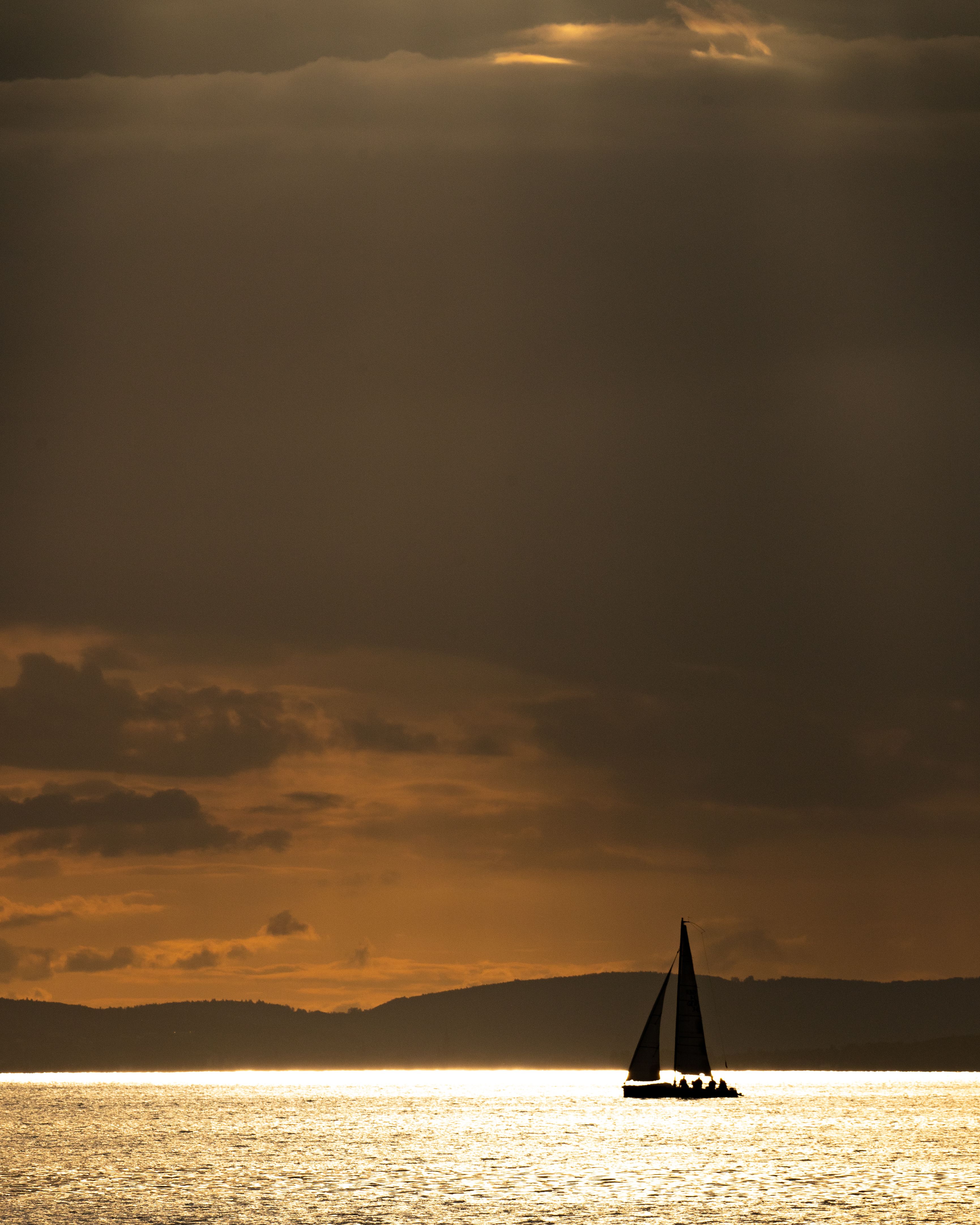 Sailboat under Rain Cloud at Sunset · Free Stock Photo
