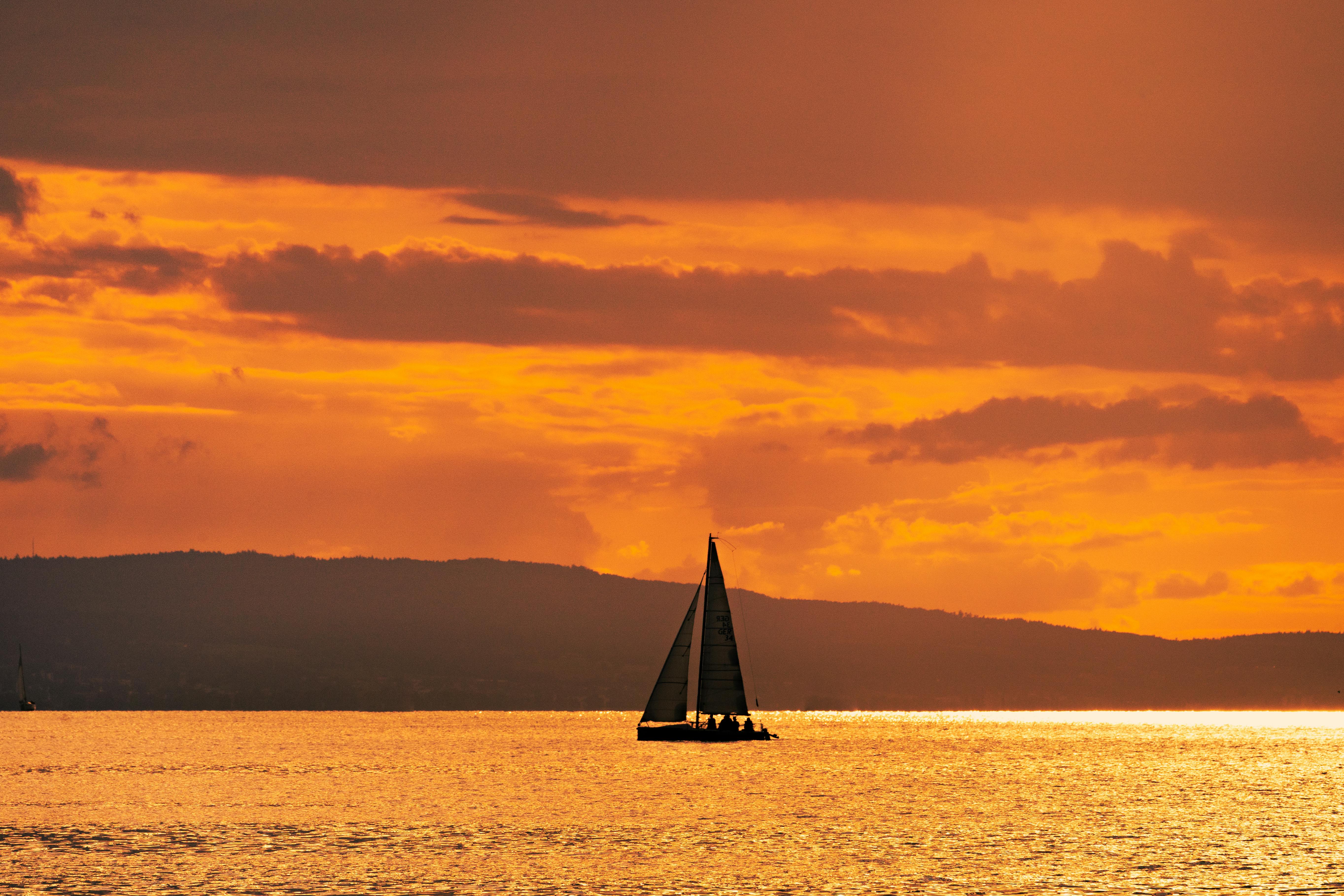 Sailboat on Lake at Sunset · Free Stock Photo