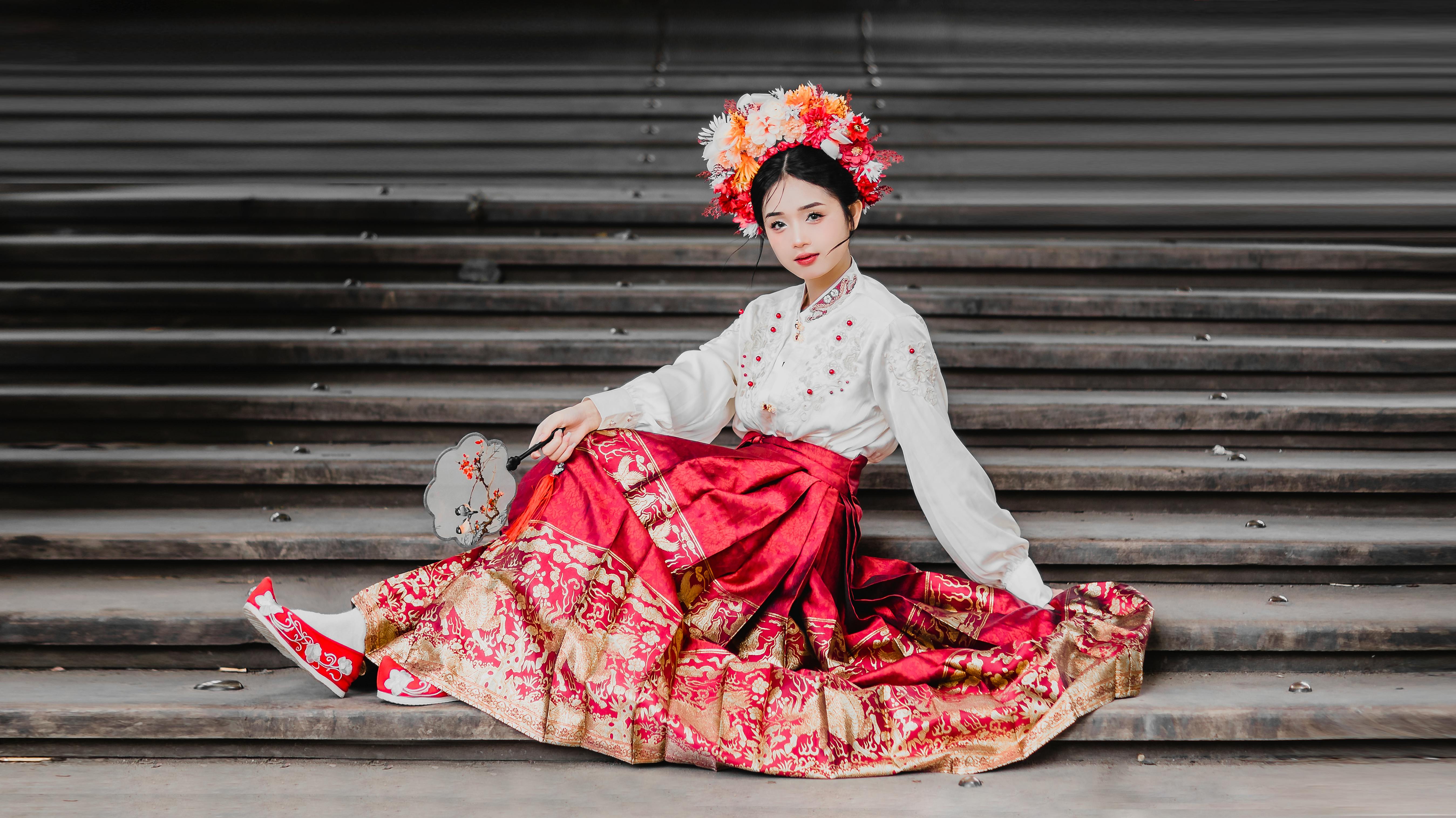 Woman in Traditional Clothing Sitting on Stairs · Free Stock Photo
