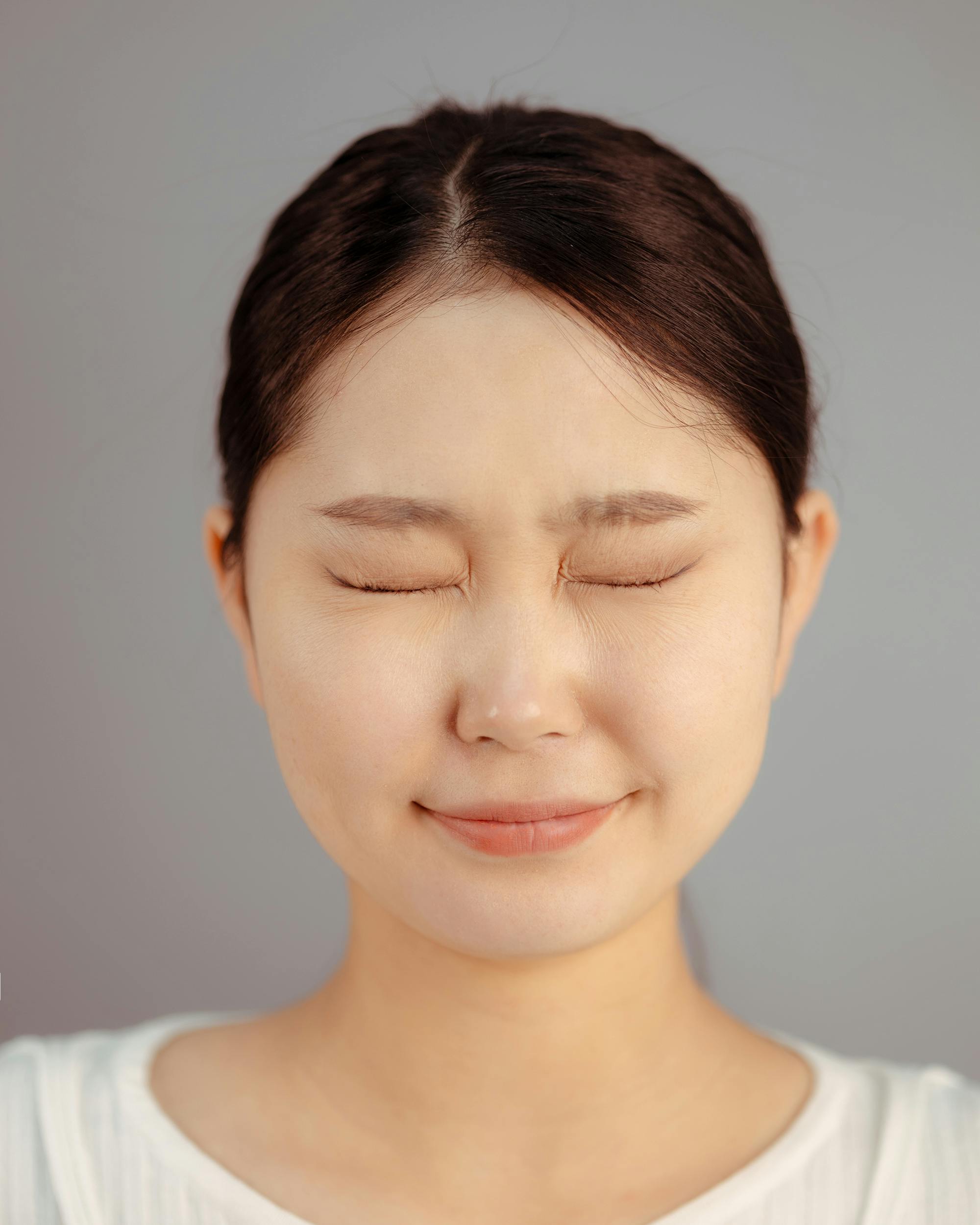 Portrait of a Young Woman Smiling with Her Eyes Shut · Free Stock Photo