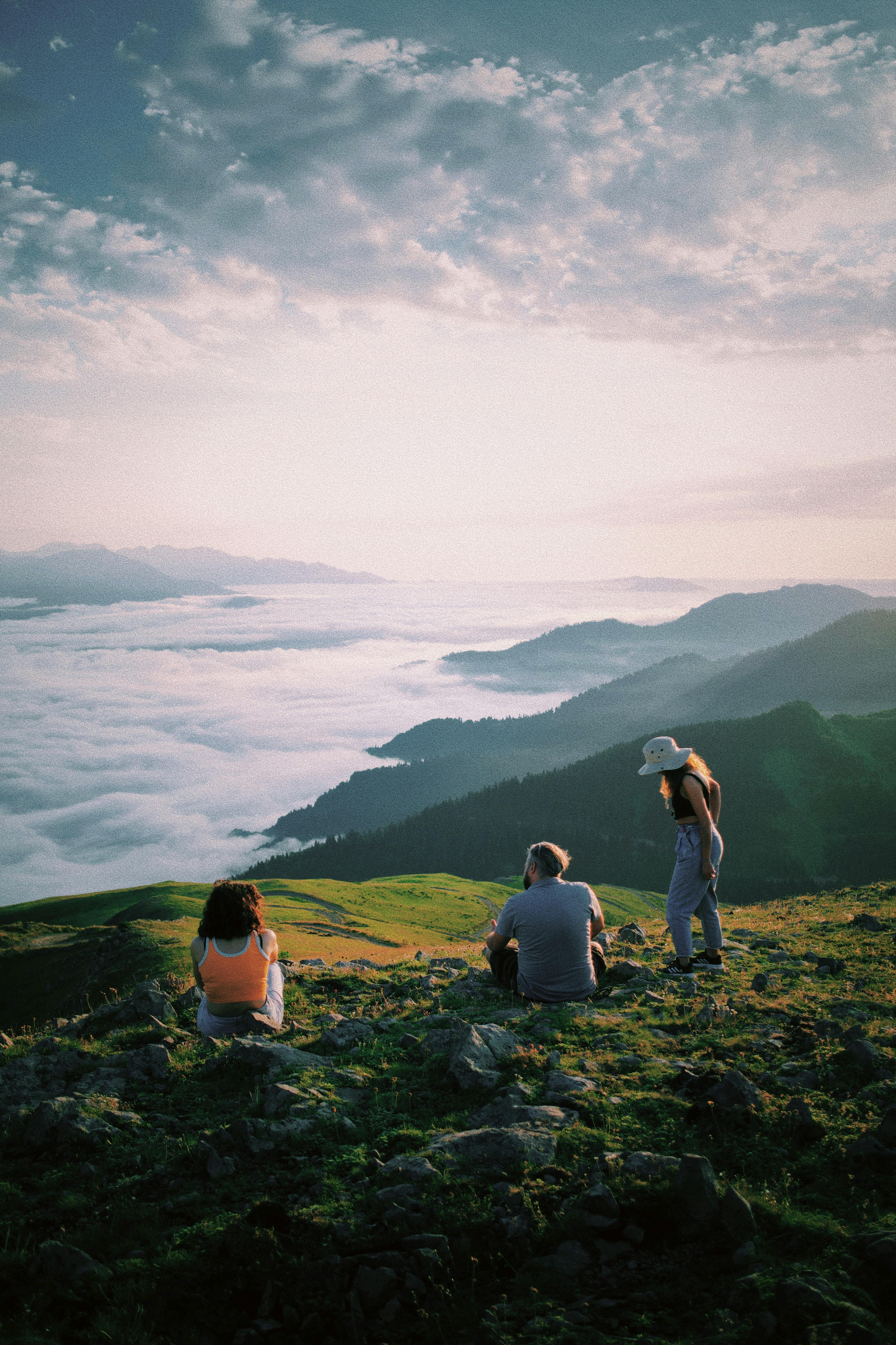 Man and Women on Hill with Cloud below · Free Stock Photo