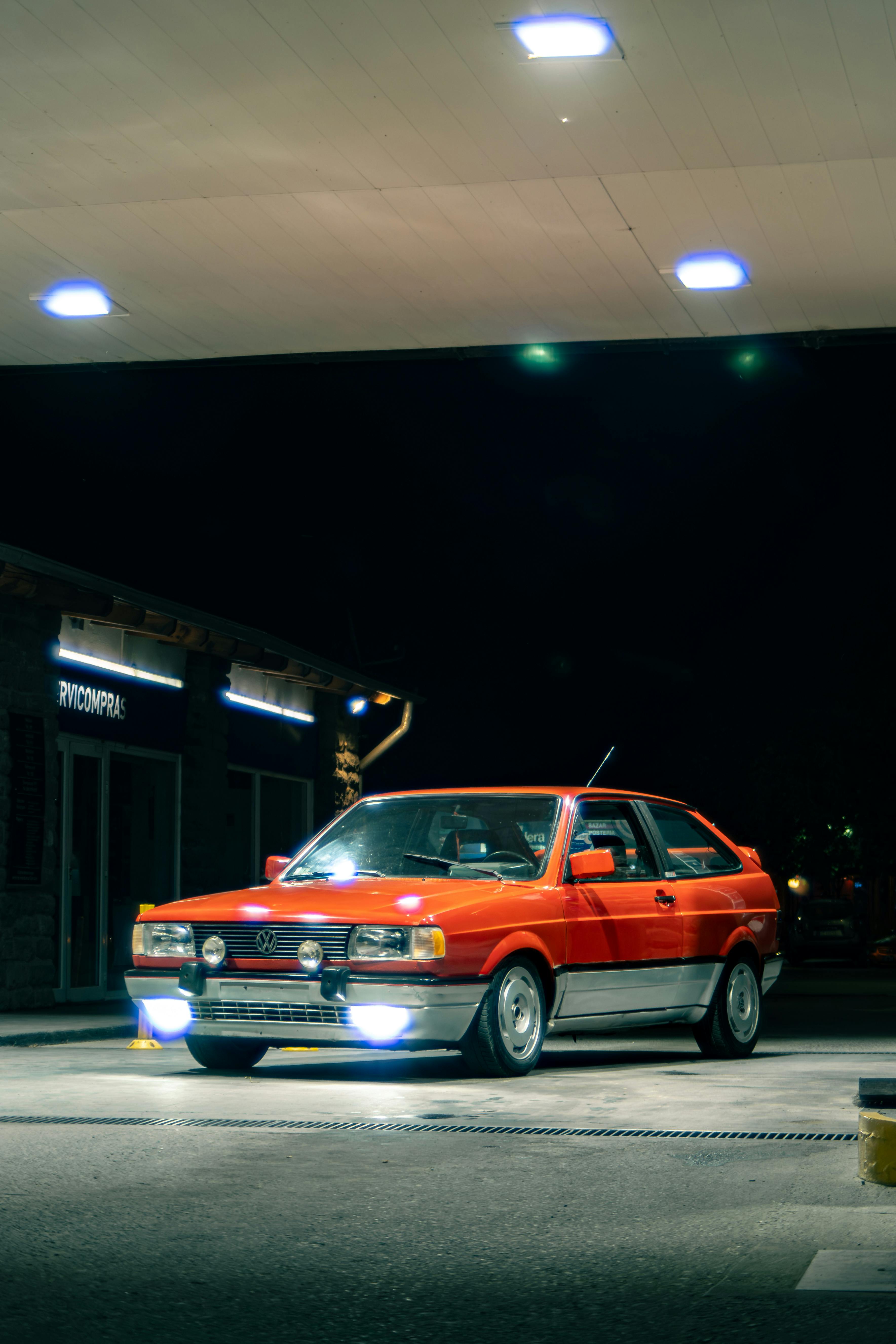 Old Red Volkswagen Fox at a Gas Station at Night · Free Stock Photo