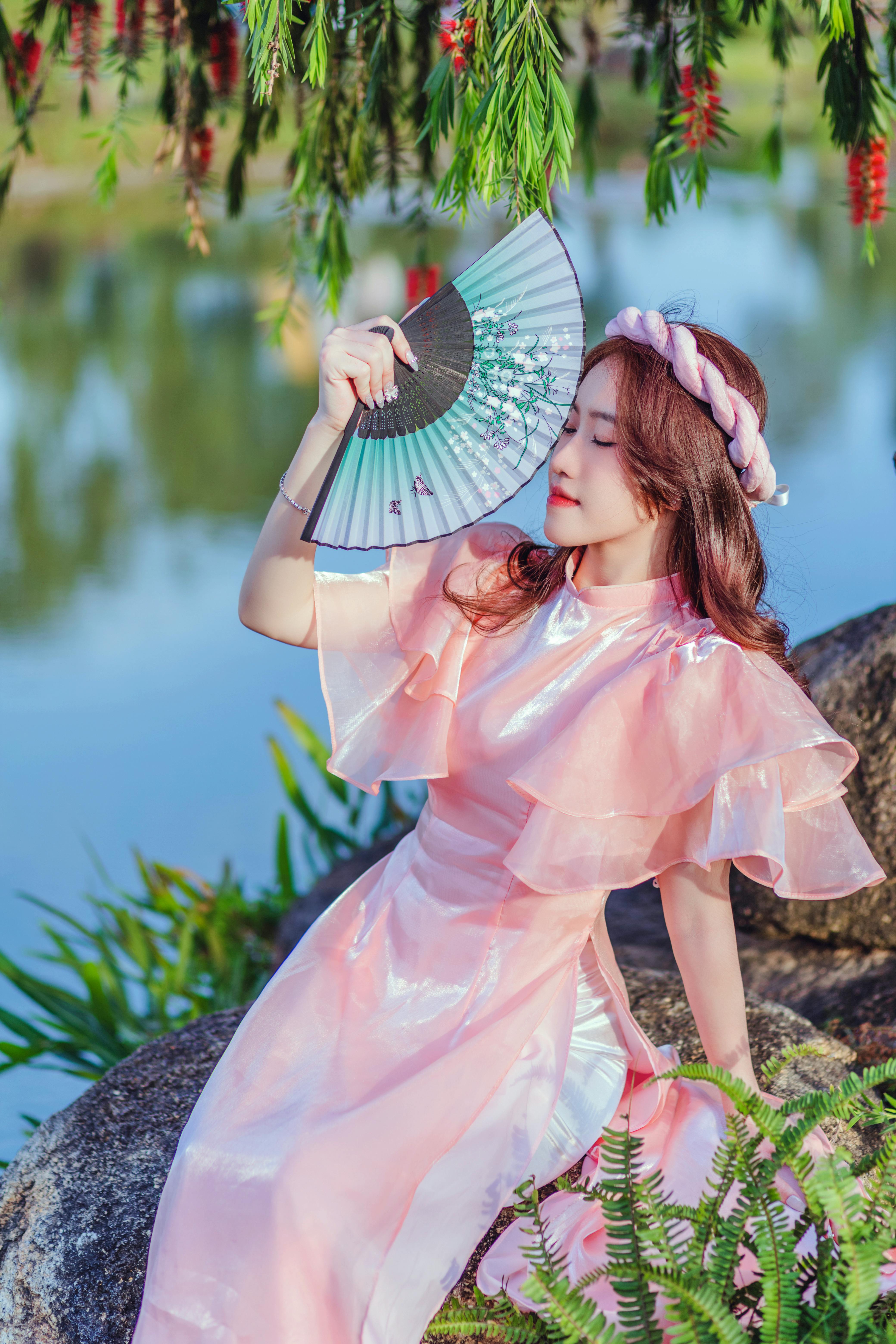 Model in Pink Dress Posing with Fan · Free Stock Photo