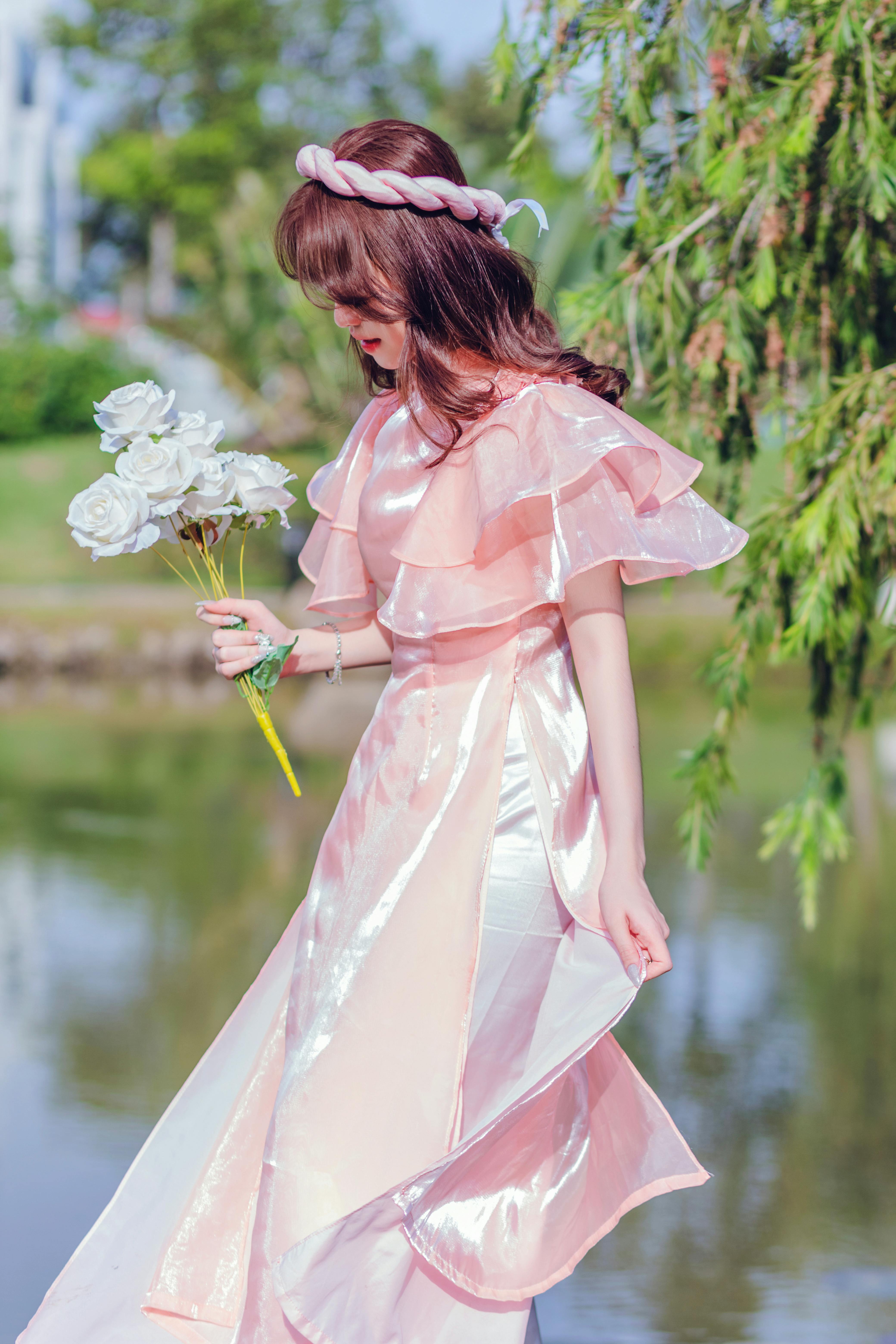 Model in Pink Dress with Flowers by Lake · Free Stock Photo