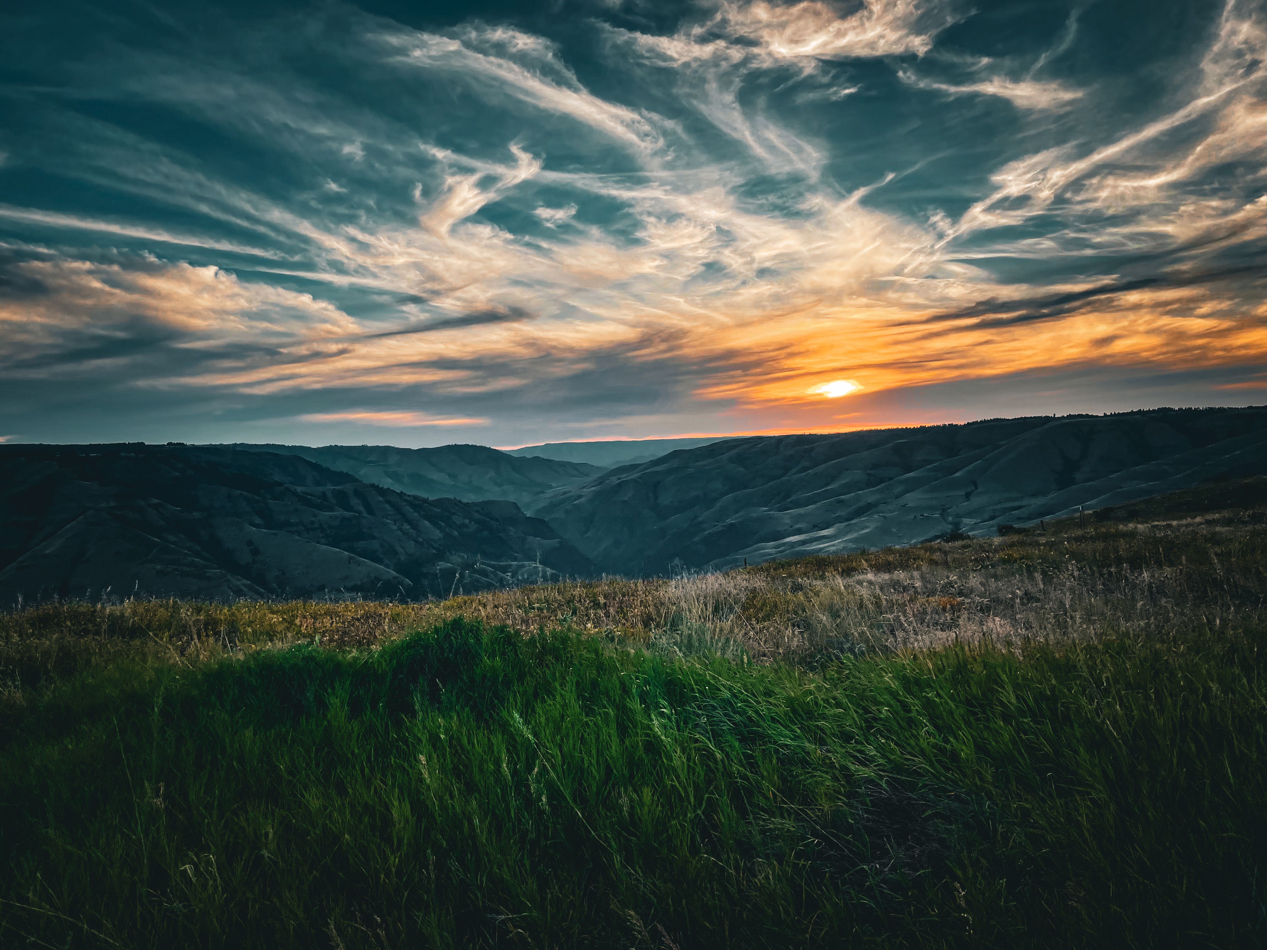 Field in a Mountain Valley During Sunset · Free Stock Photo