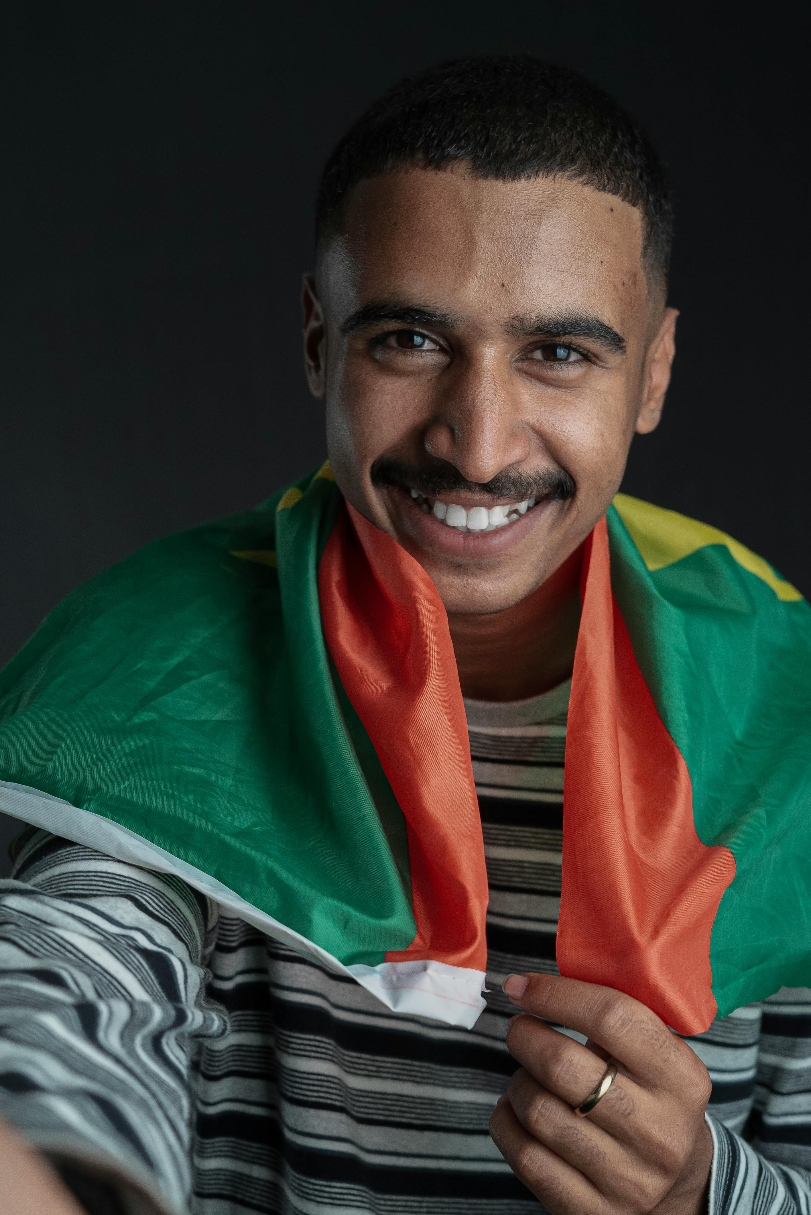 Portrait of Smiling Man Holding Flag · Free Stock Photo